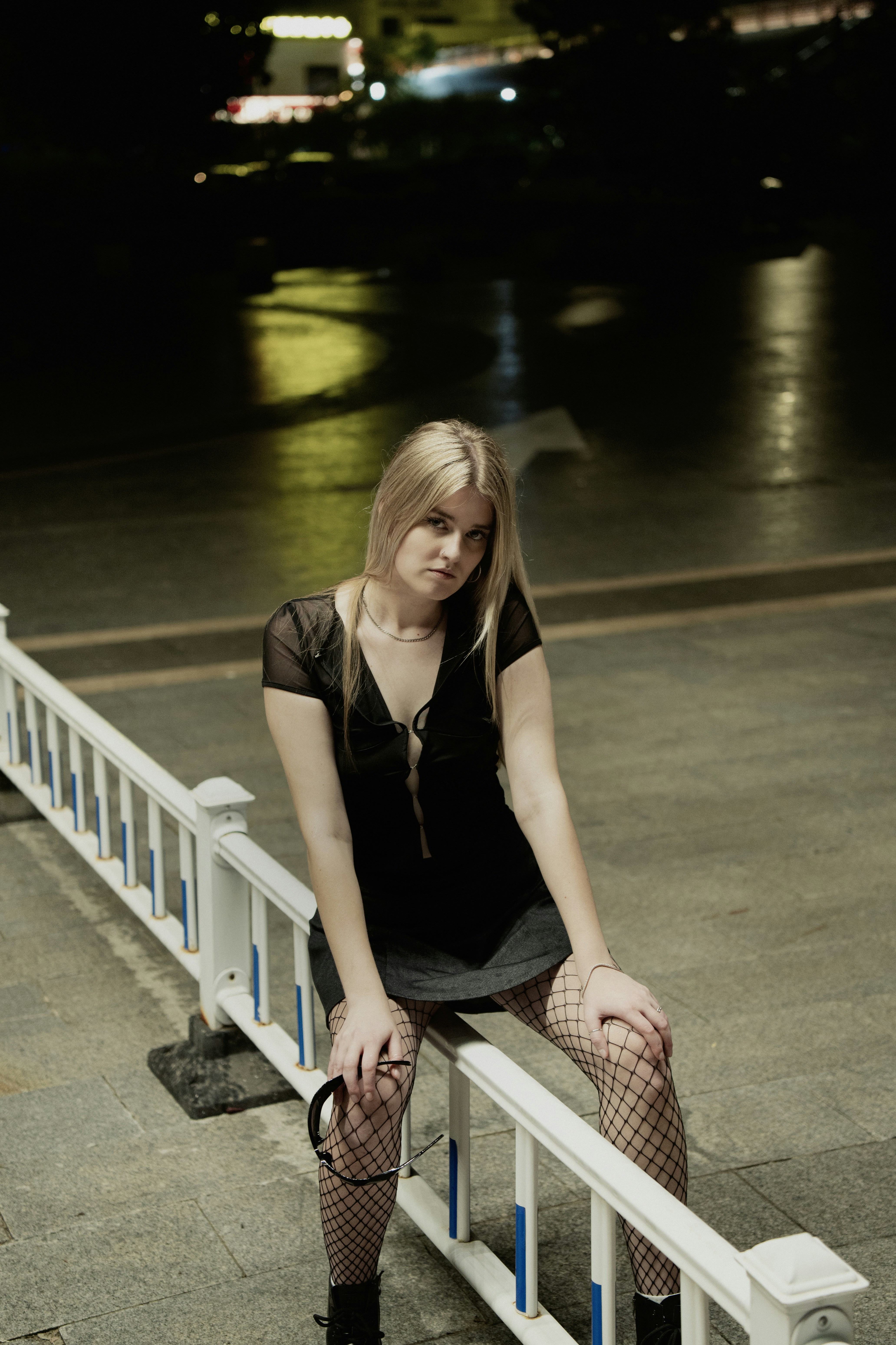 Midnight Riverside Portrait: A Blonde Rebel on the Rail