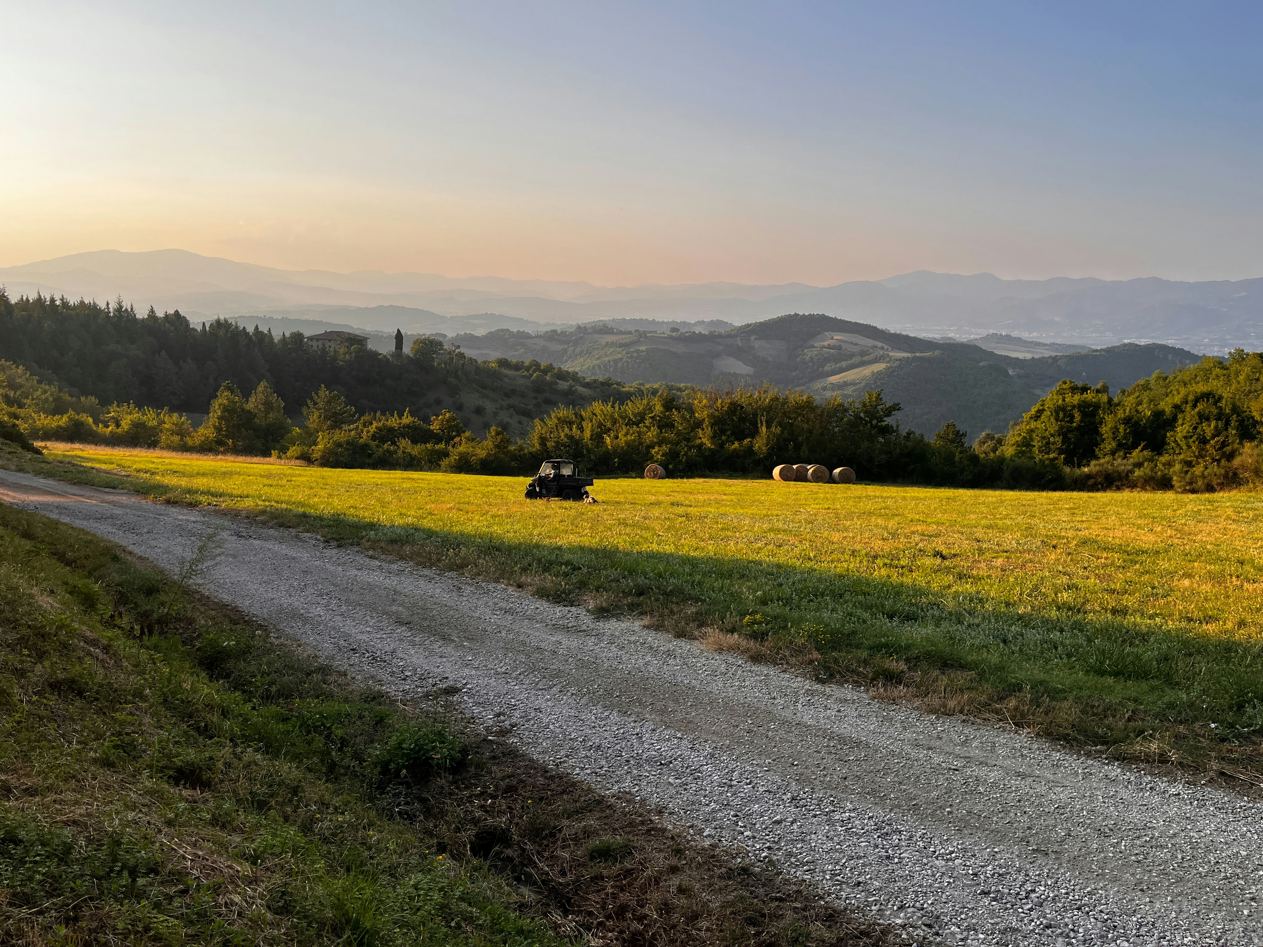 Golden Hour Gates: Rolling Field and Distant Peaks