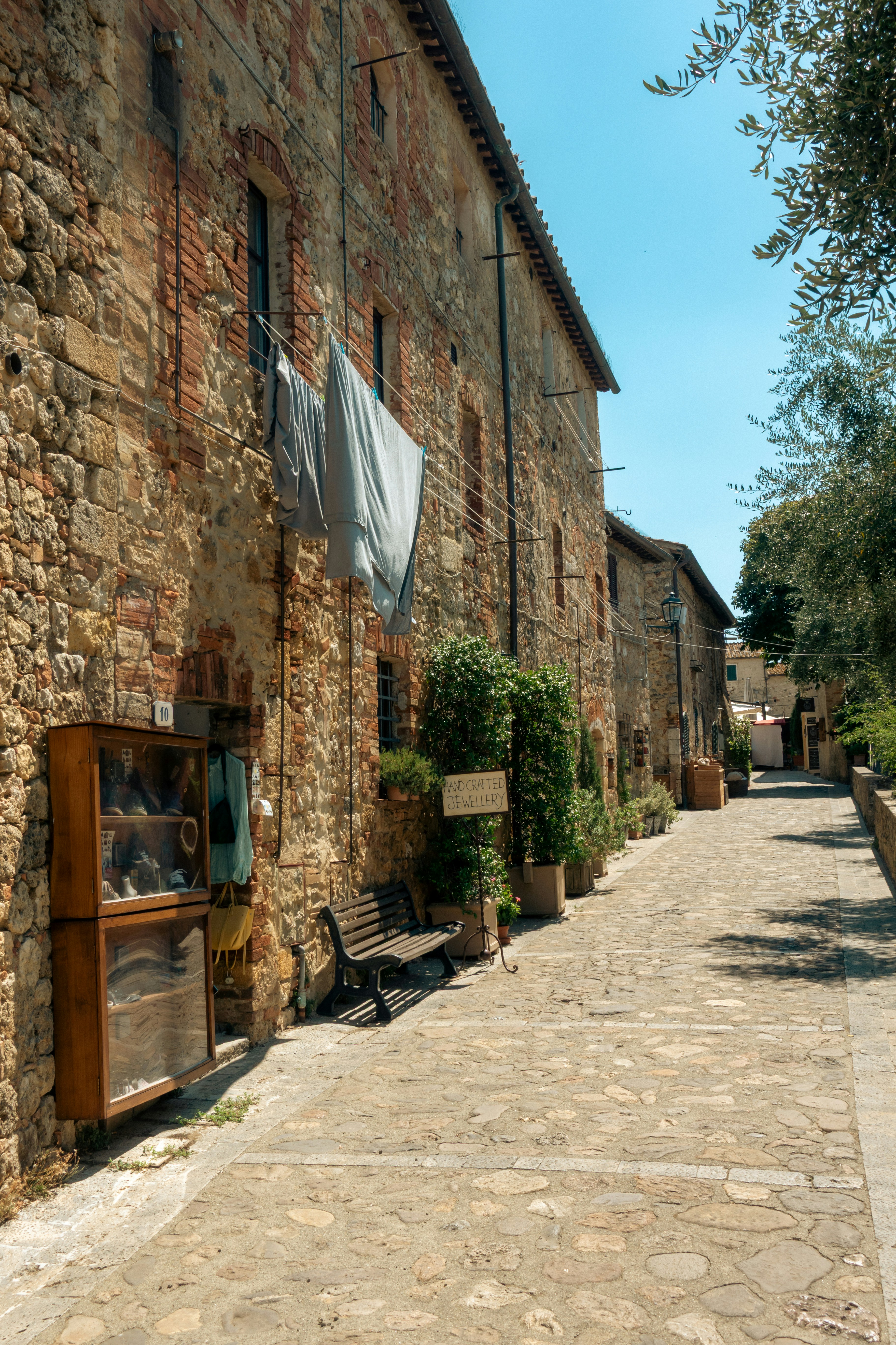 Sunlit Alley of Stone and Laundry