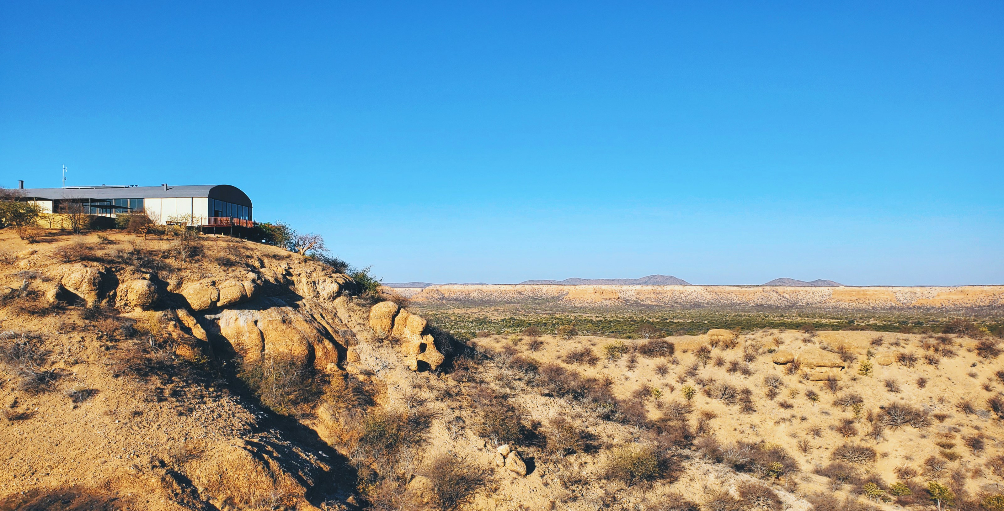 Desert Rim House Above the Arid Plain