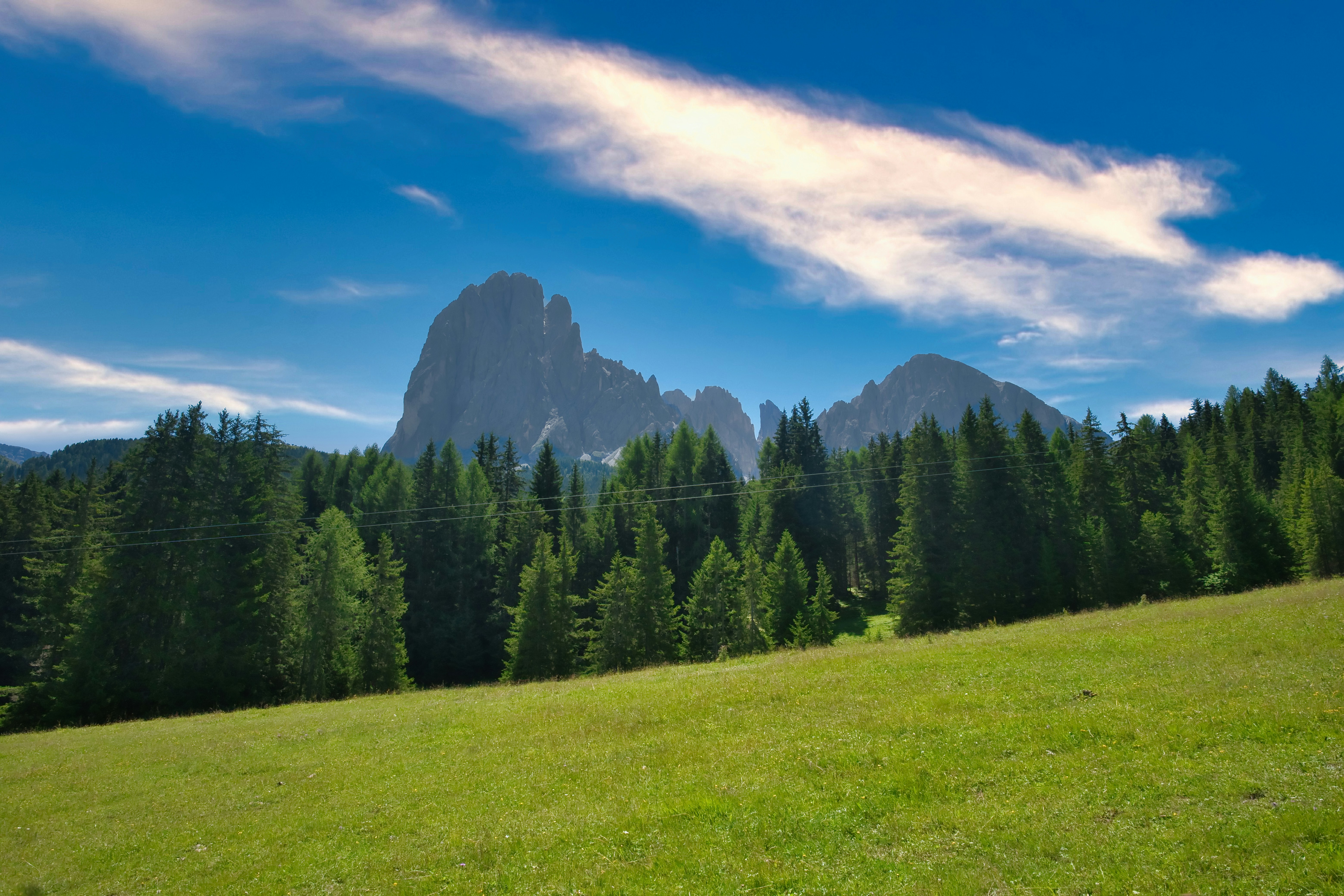 Majestic Peaks Rising Over a Sunlit Meadow