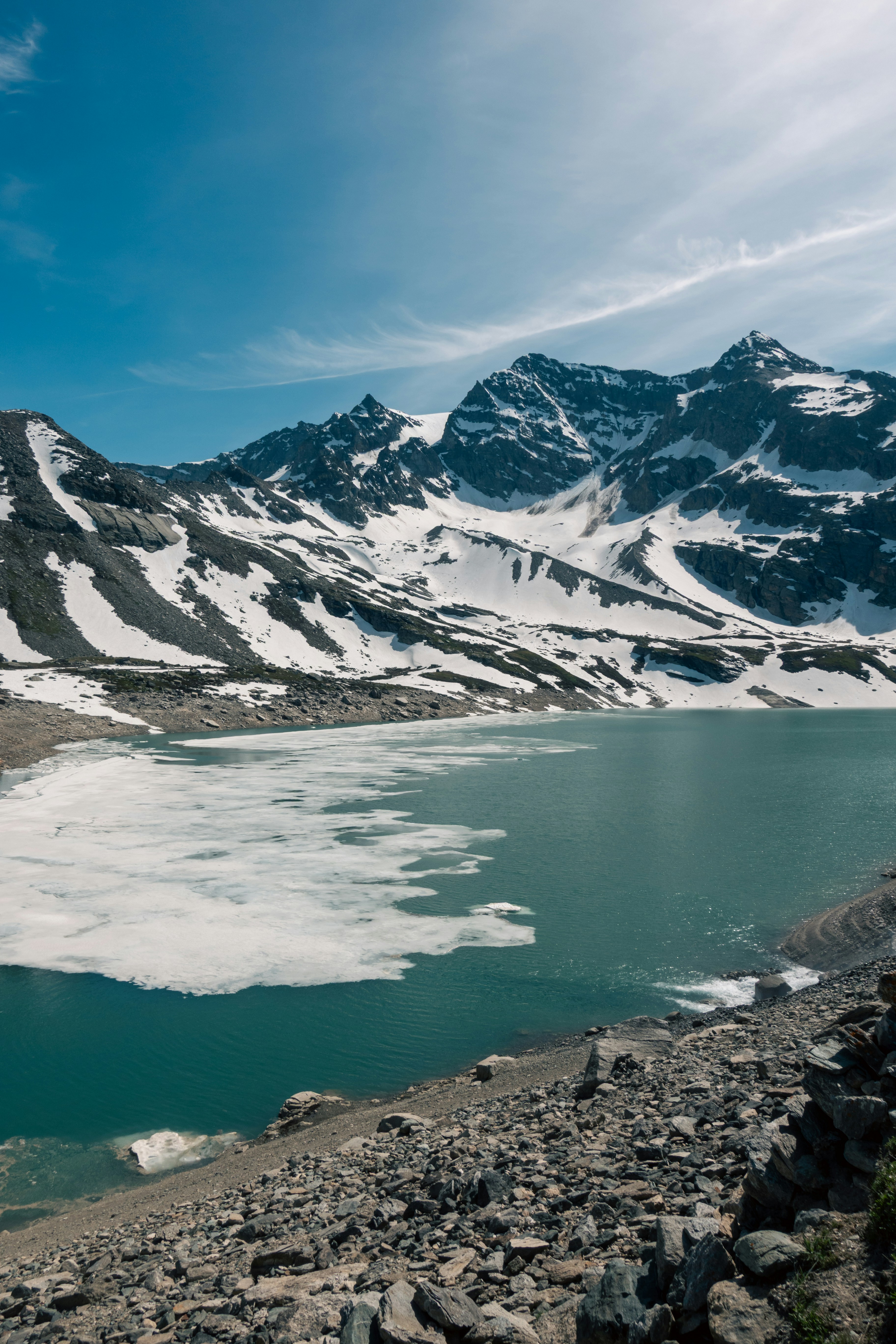Glacial Reach: A Turquoise Lake and Snowbound Ridge