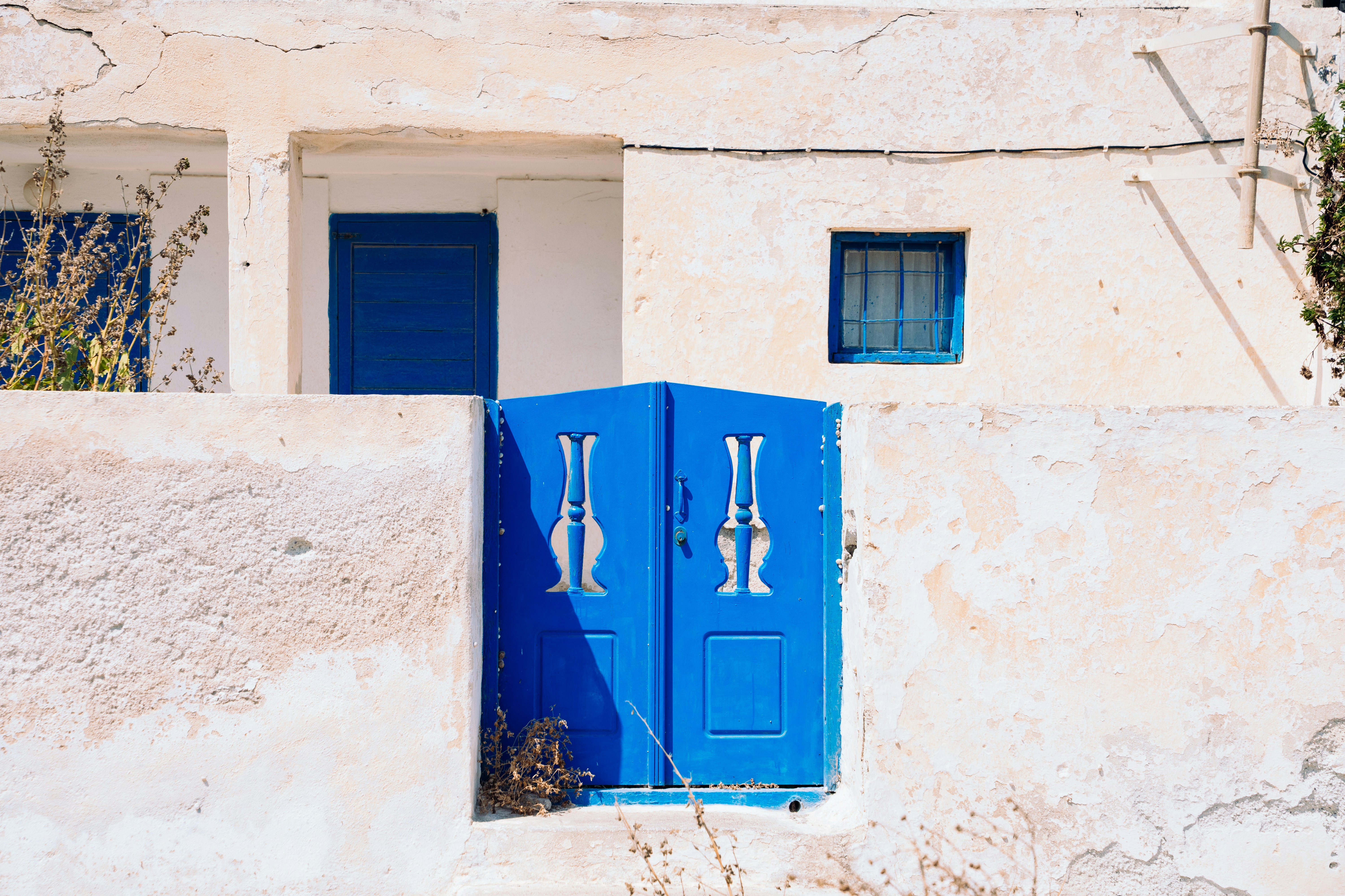 Azure Gate on sunlit limestone: a quiet doorway in a Cycladic wall