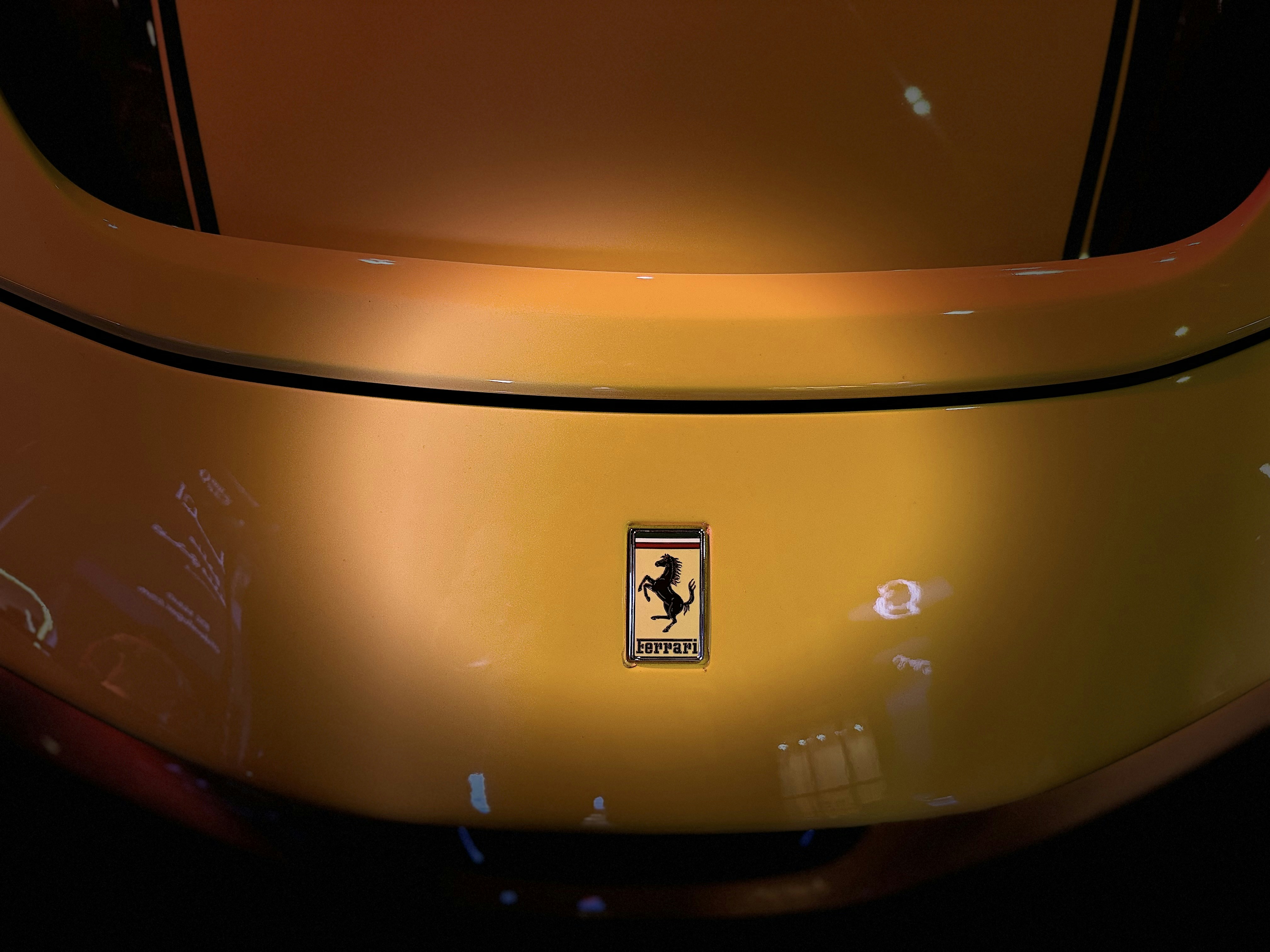 Emblem in Golden Studio: Ferrari Badge on Car Hood