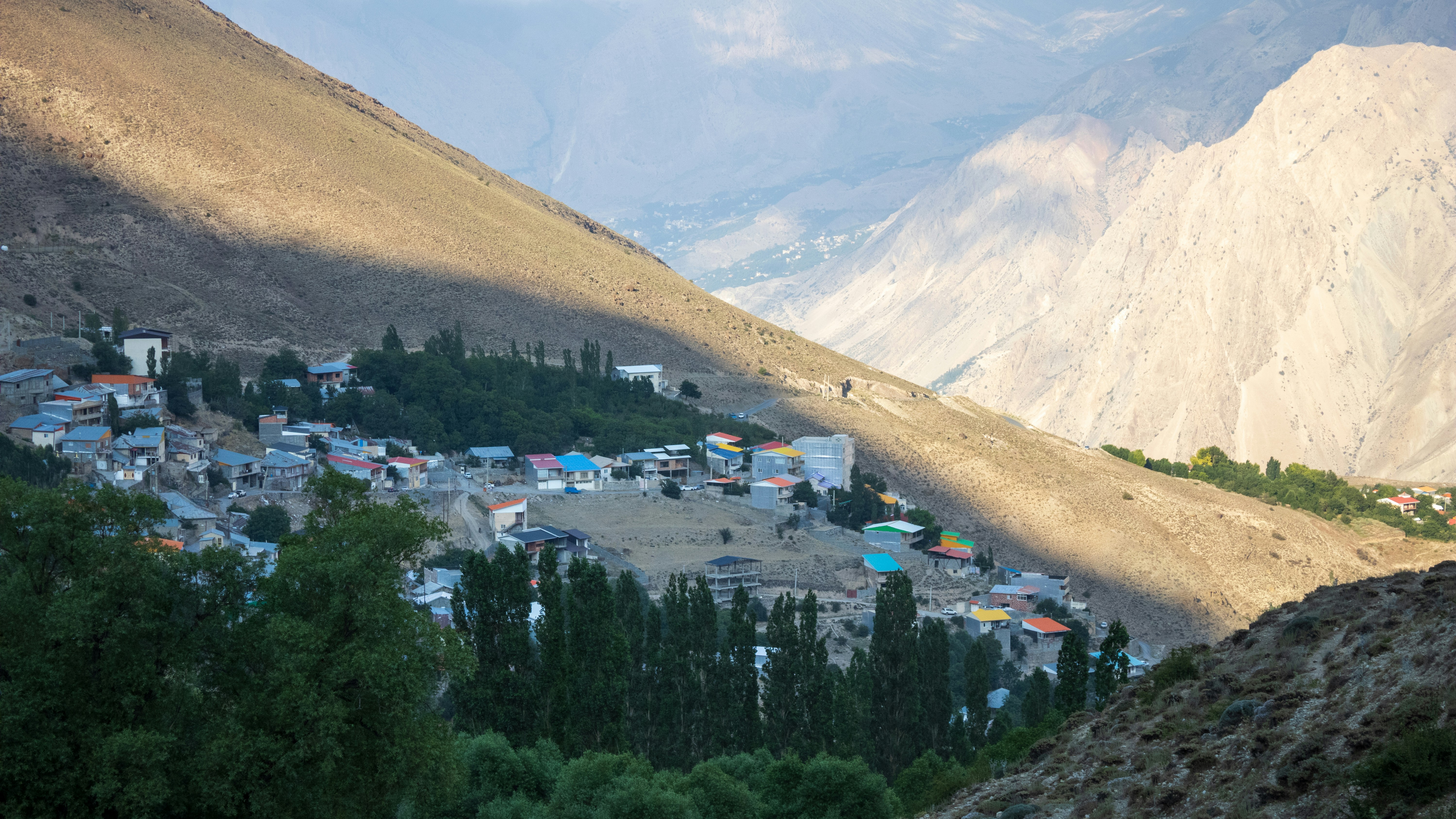 Colorful hillside village tucked between silent peaks