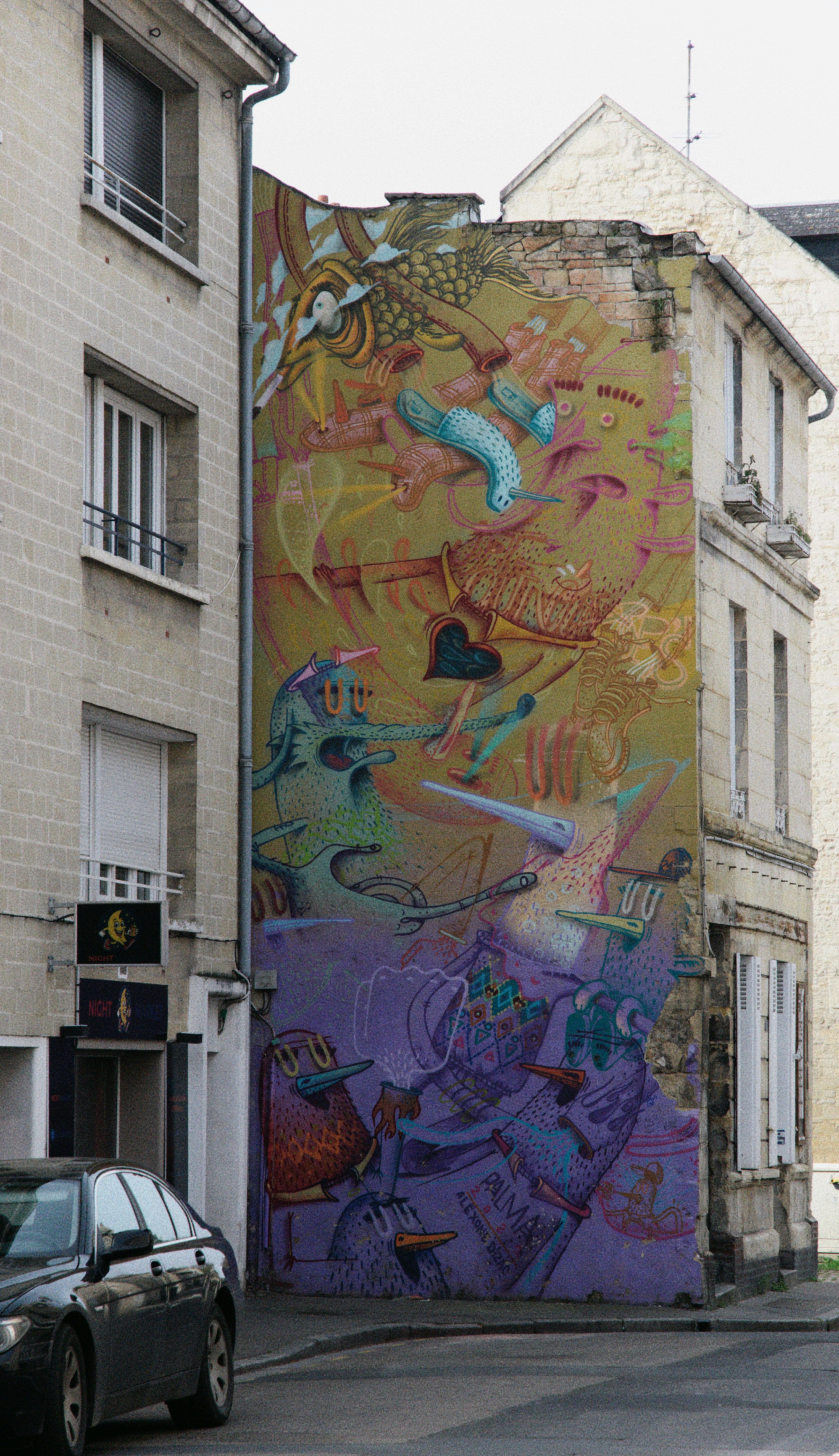 Vibrant Street Mosaic: A Rainbow of Shapes Climbing a City Wall
