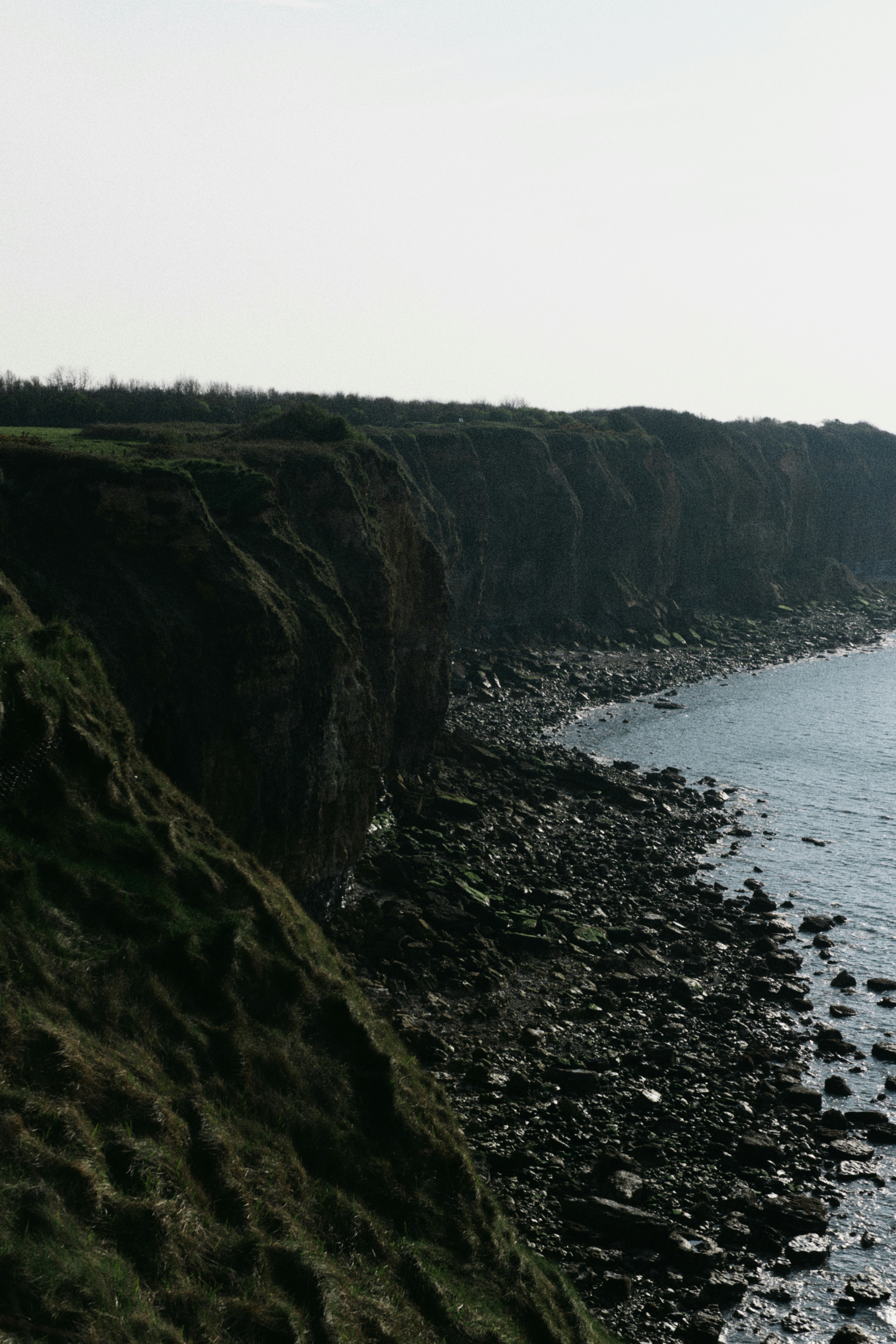 Cliffside Coastline: Sunlit Prominence Along Rugged Shore