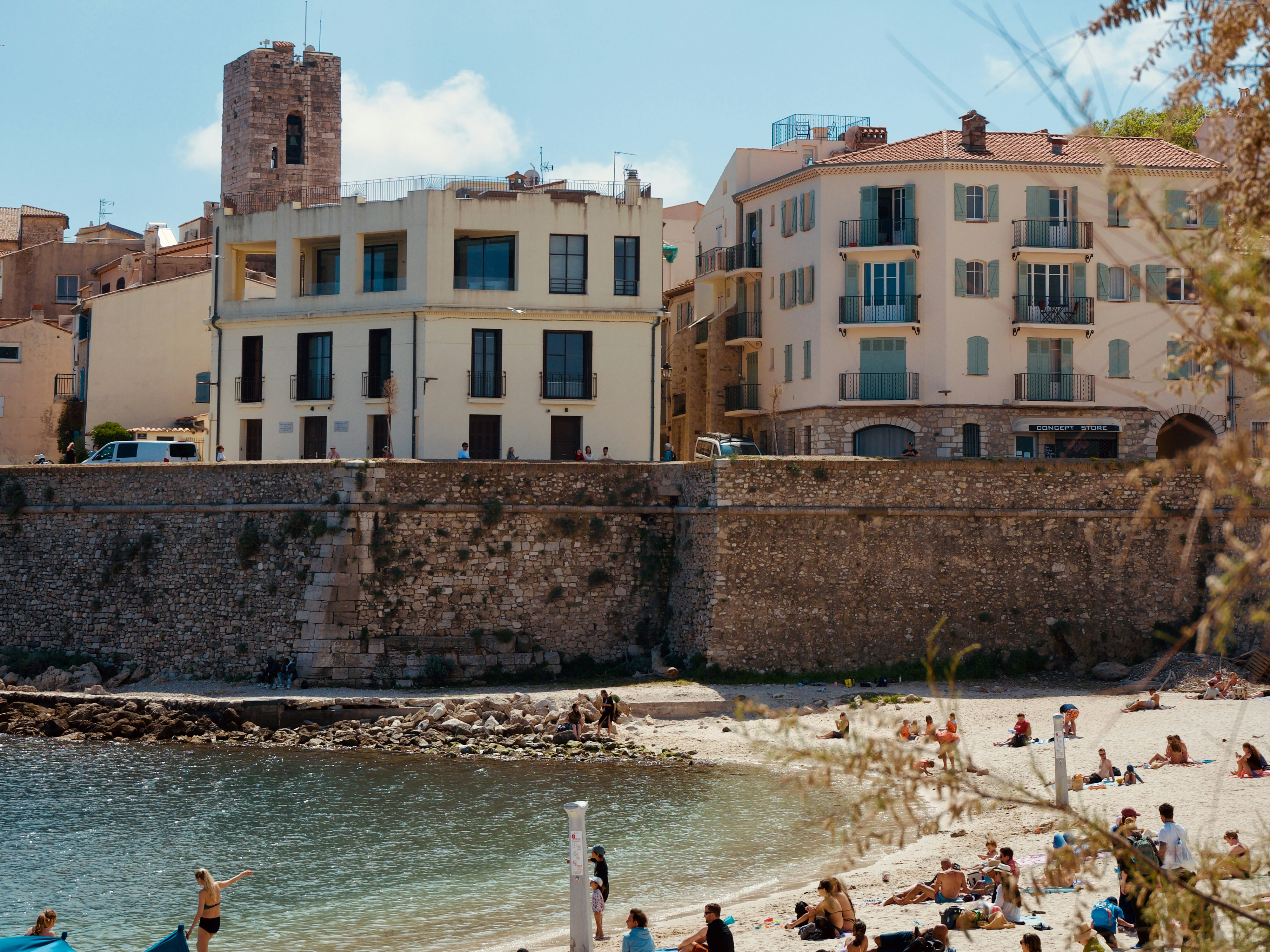 Coastal Mediterranean: Sunlit Row of pastel facades Overlooking a Quiet Beach