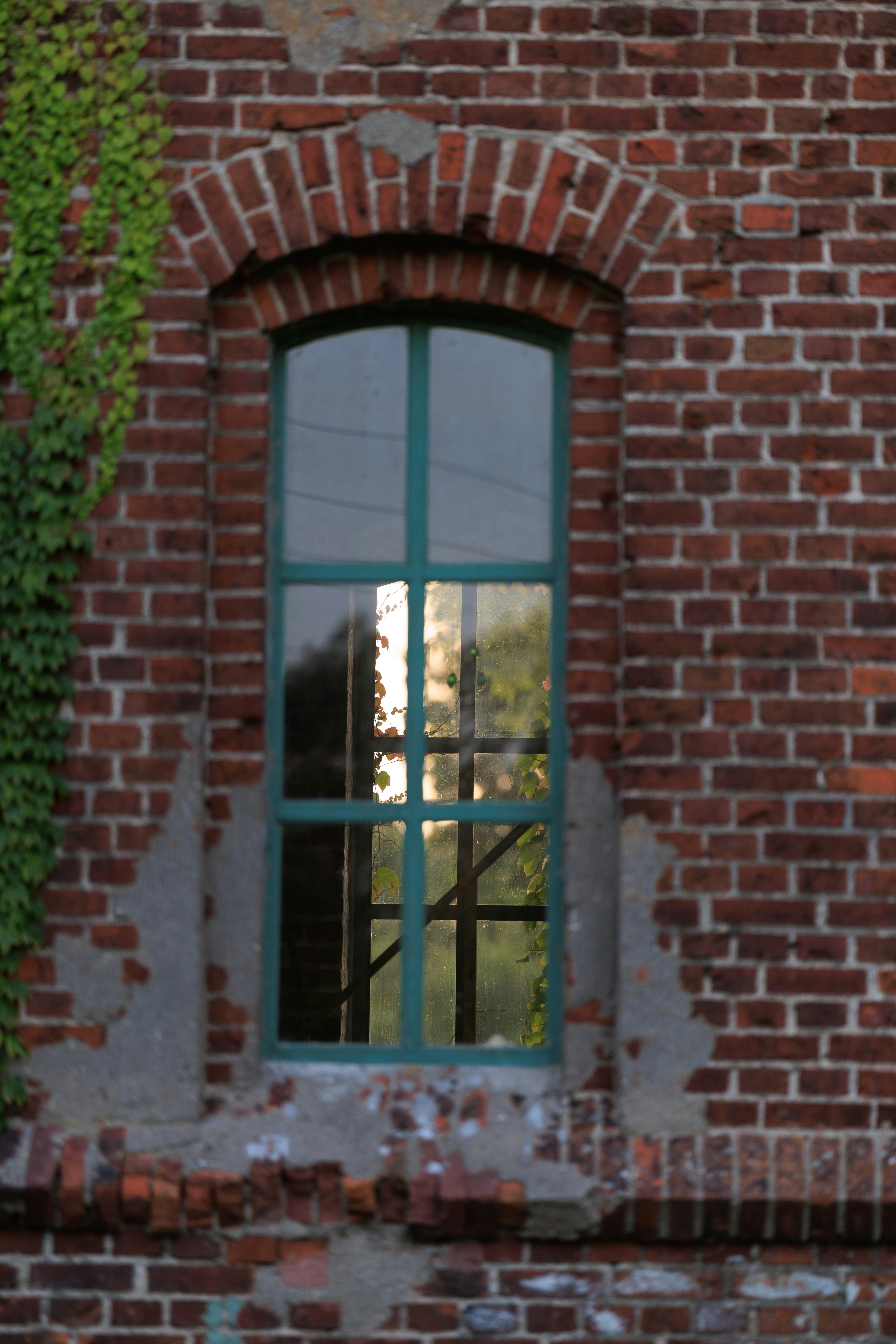 Rusted Brick Behind a Turquoise Window