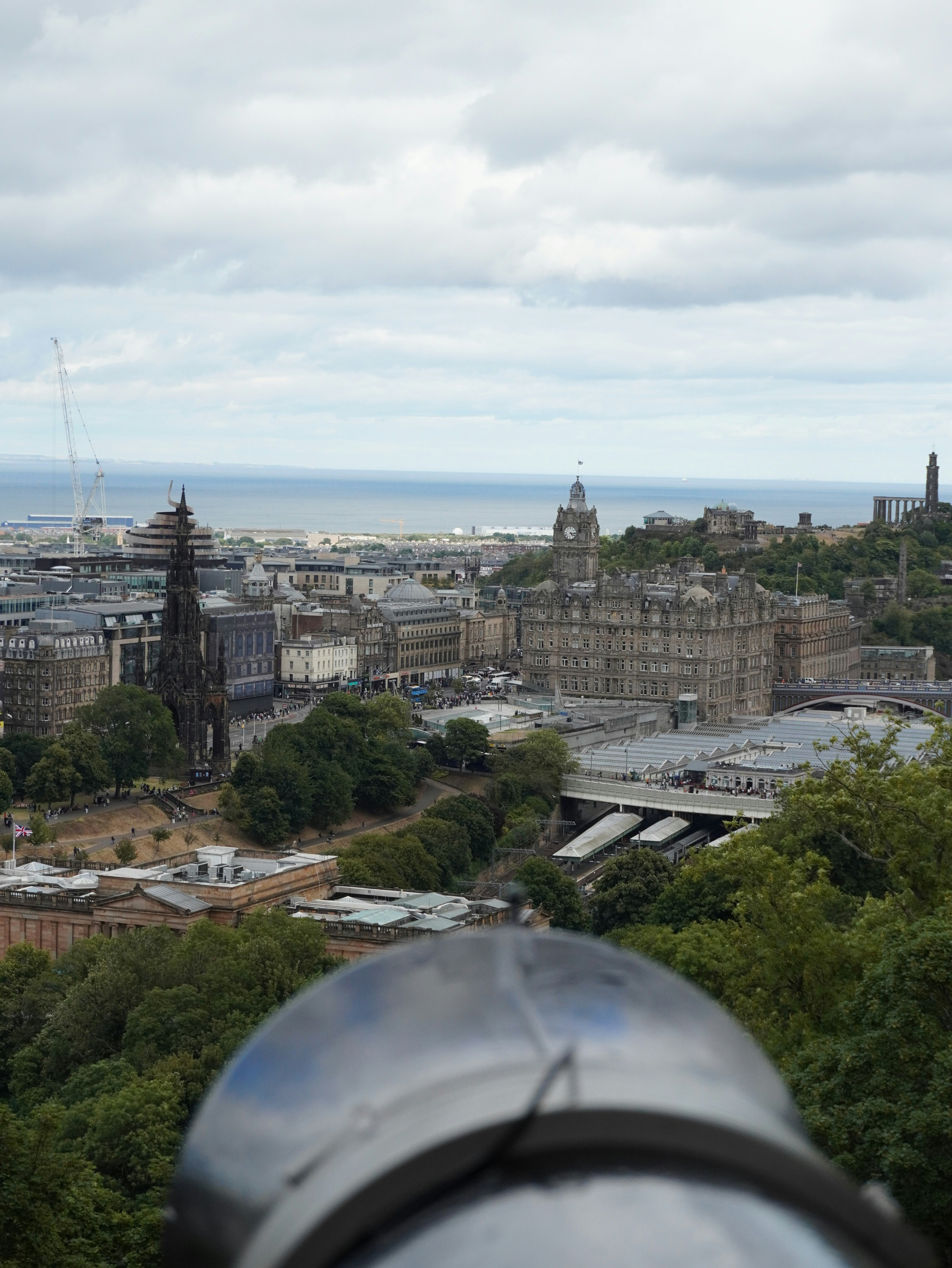 Arcing View: Cityscape framed by a distant cannon at the foreground