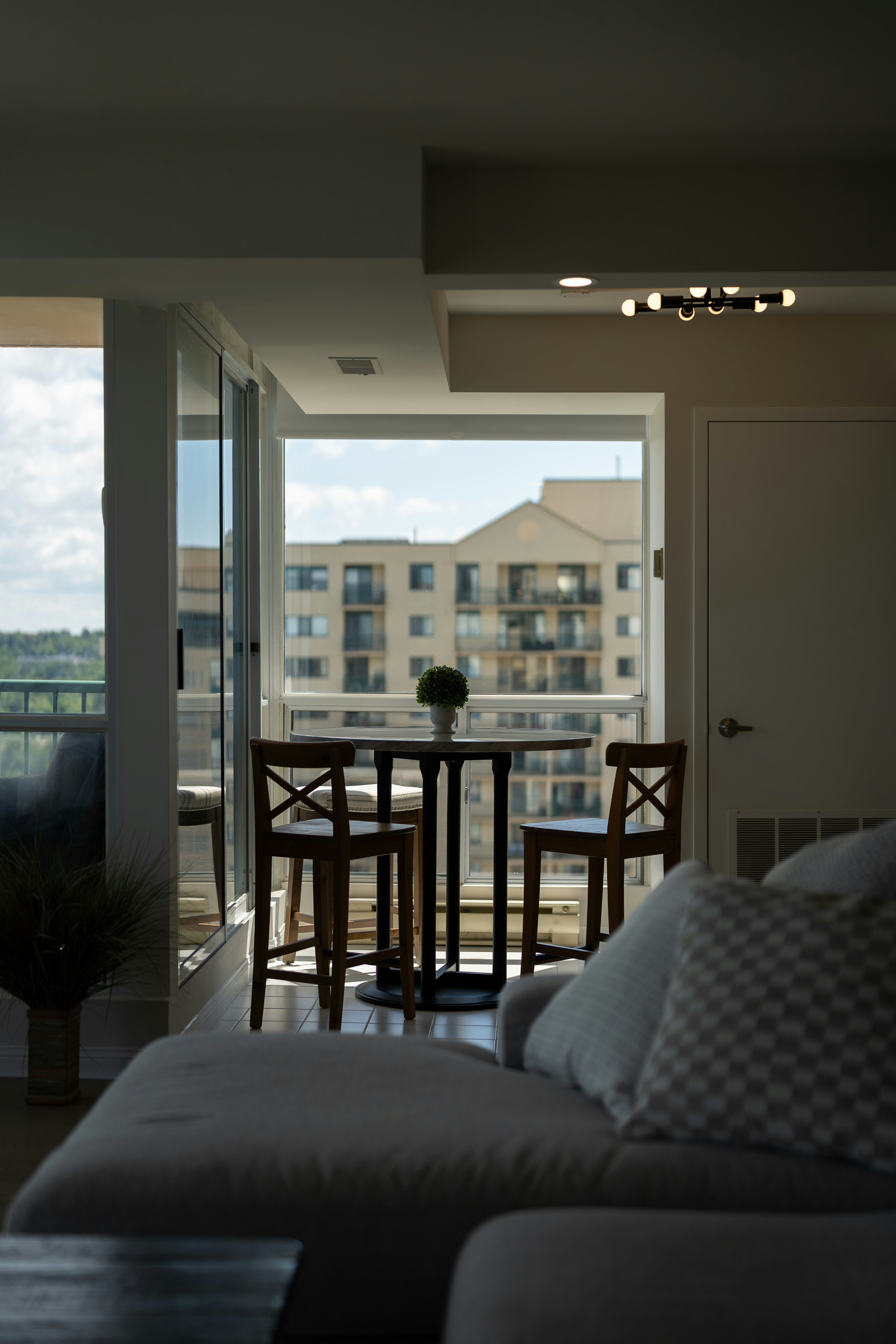 Sunlit Balcony Bistro: A Minimalist Moment in Urban Light