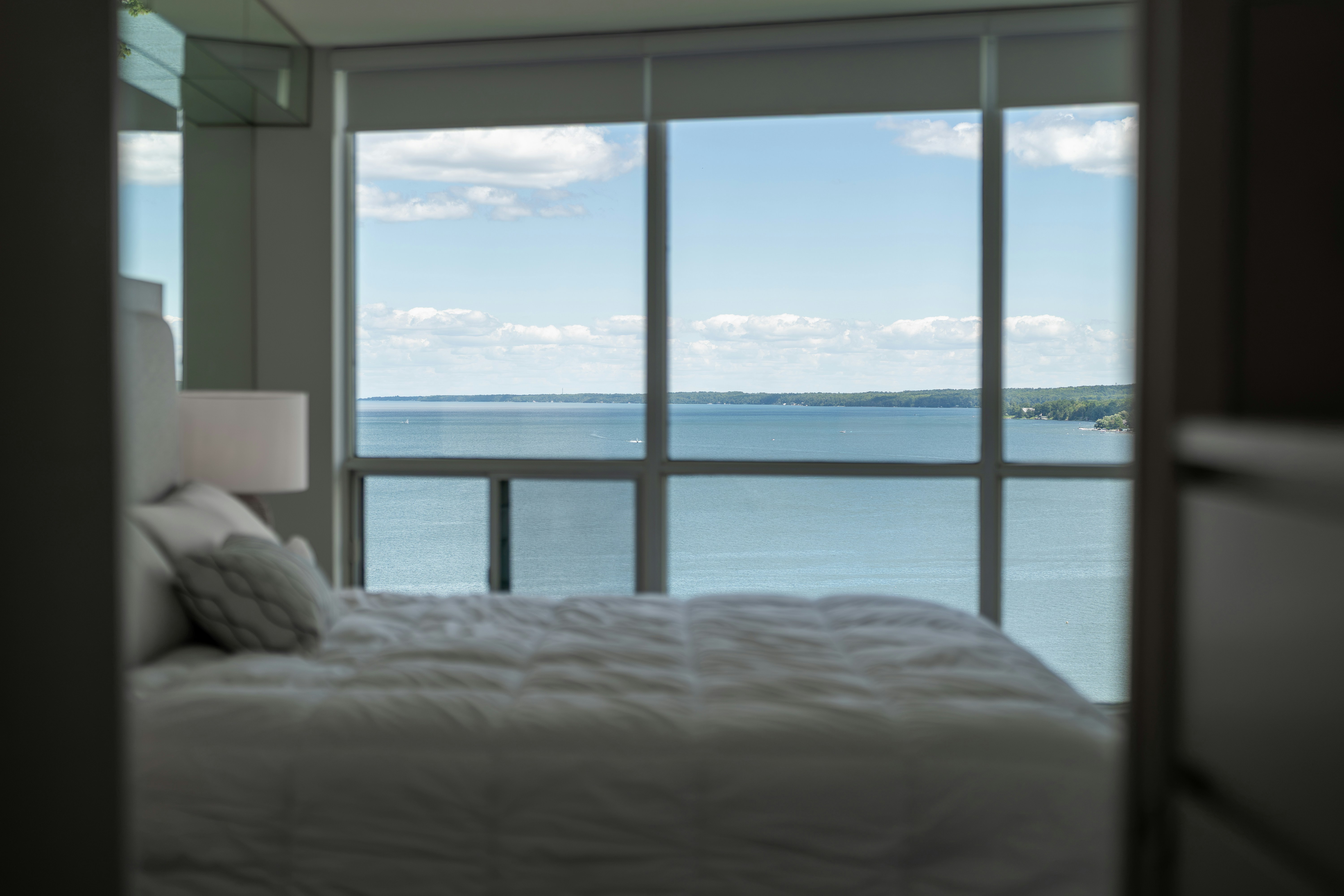 Ocean View through a Framed Window from a Minimalist Bedroom