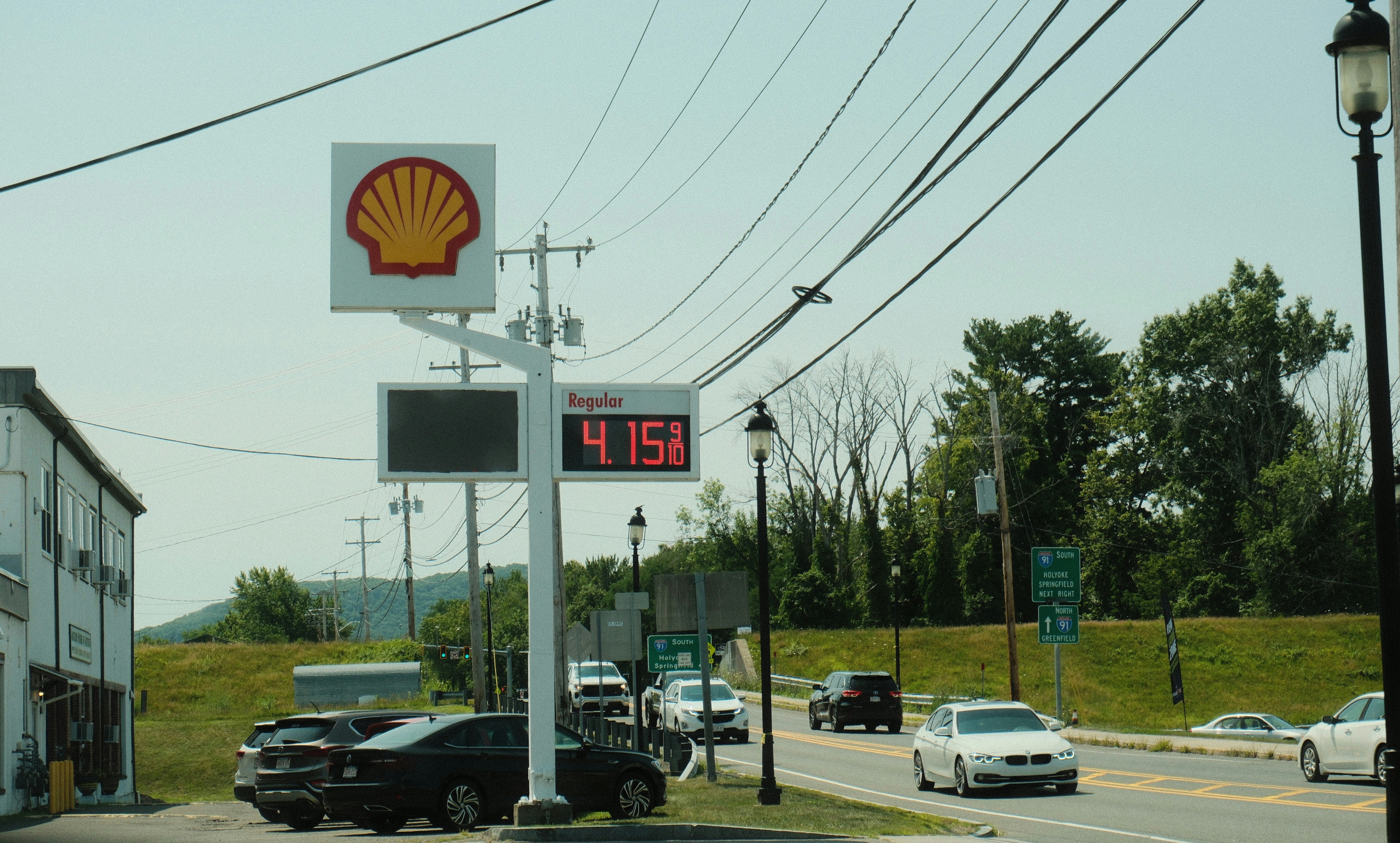 Shell Sign and Gas Station Front at Busy Rural Intersection