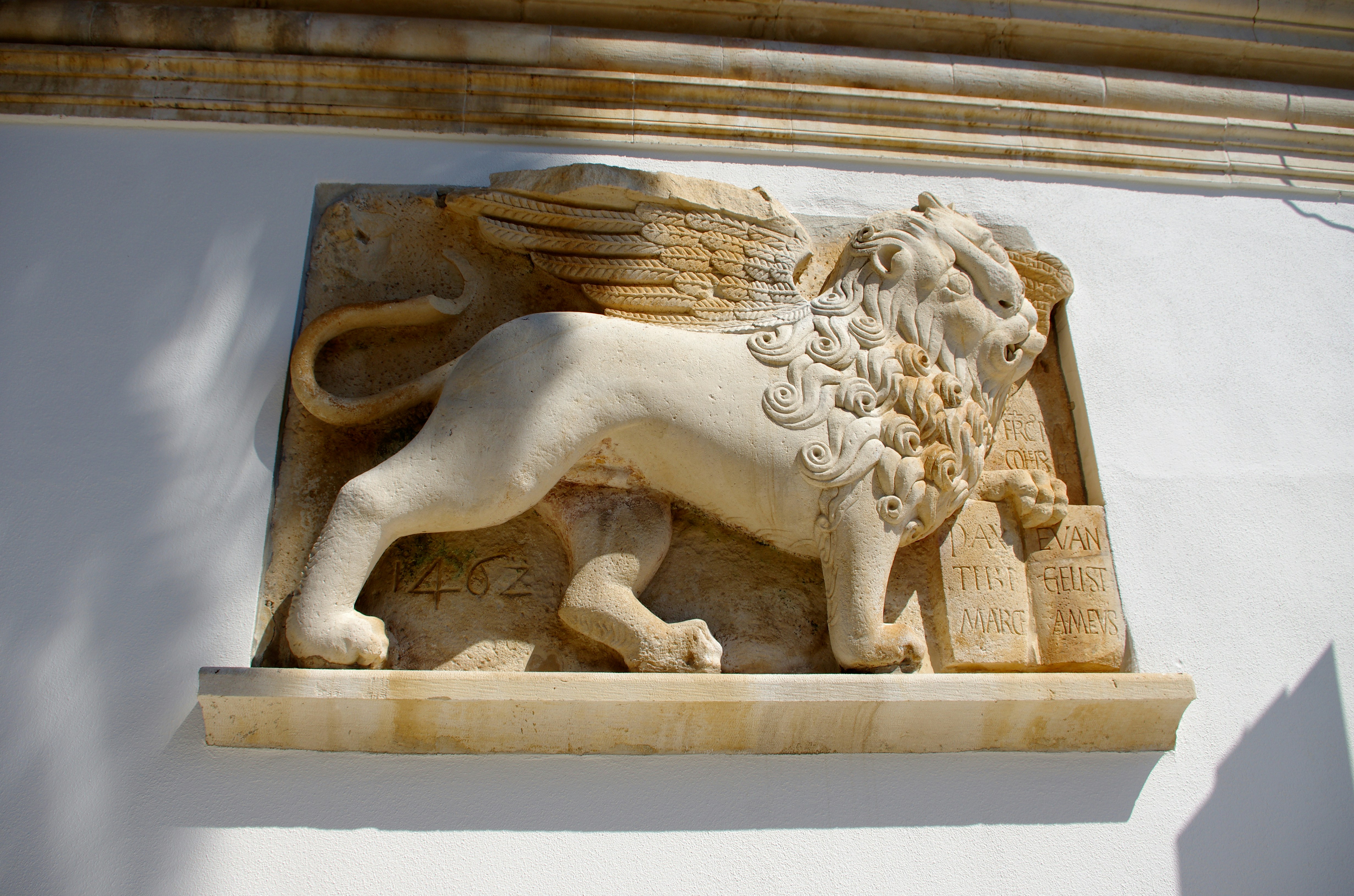 Winged Lion Relief on a Sunlit Plaster Wall