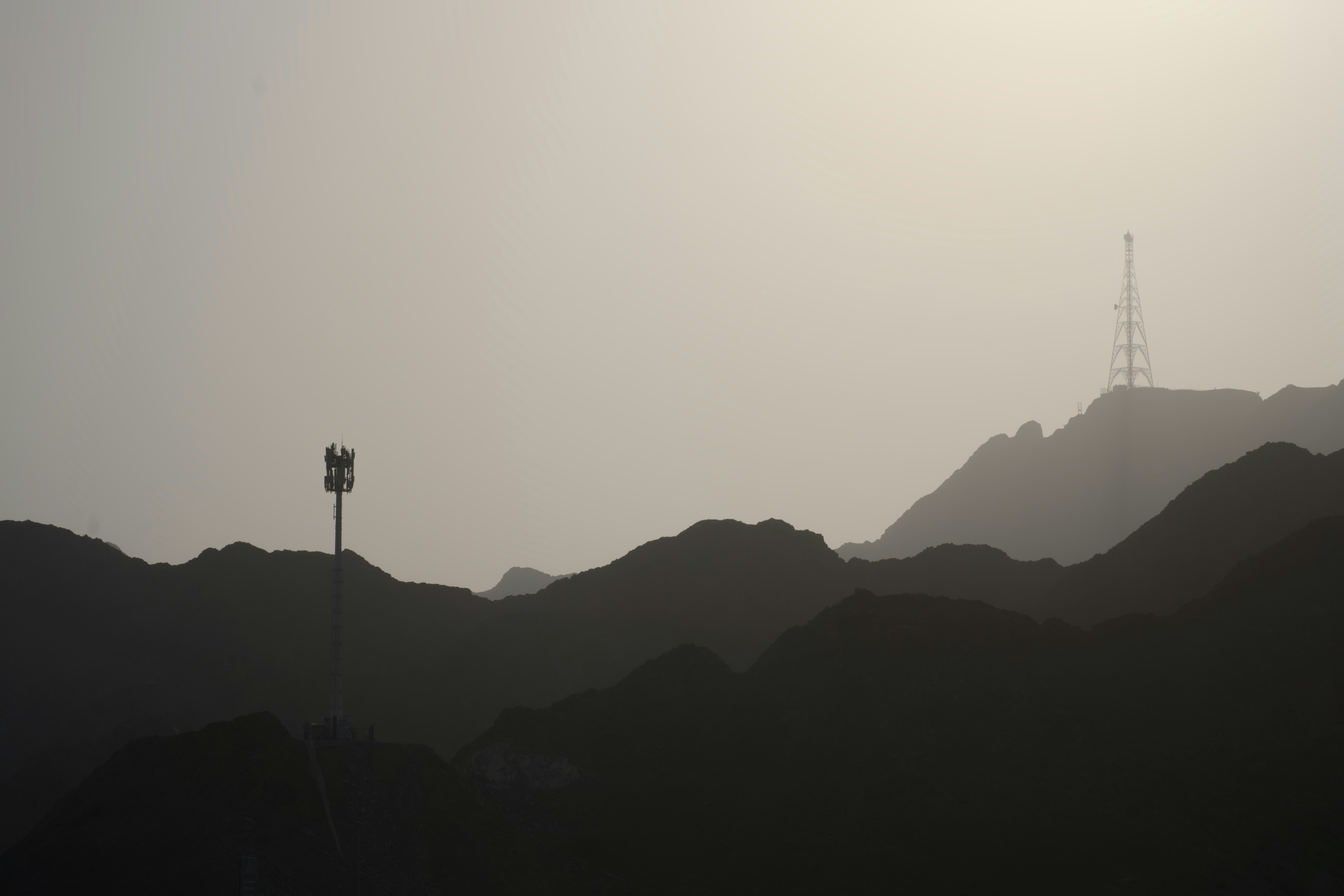 Silhouetted Ridge at Dusk with Communication Tower