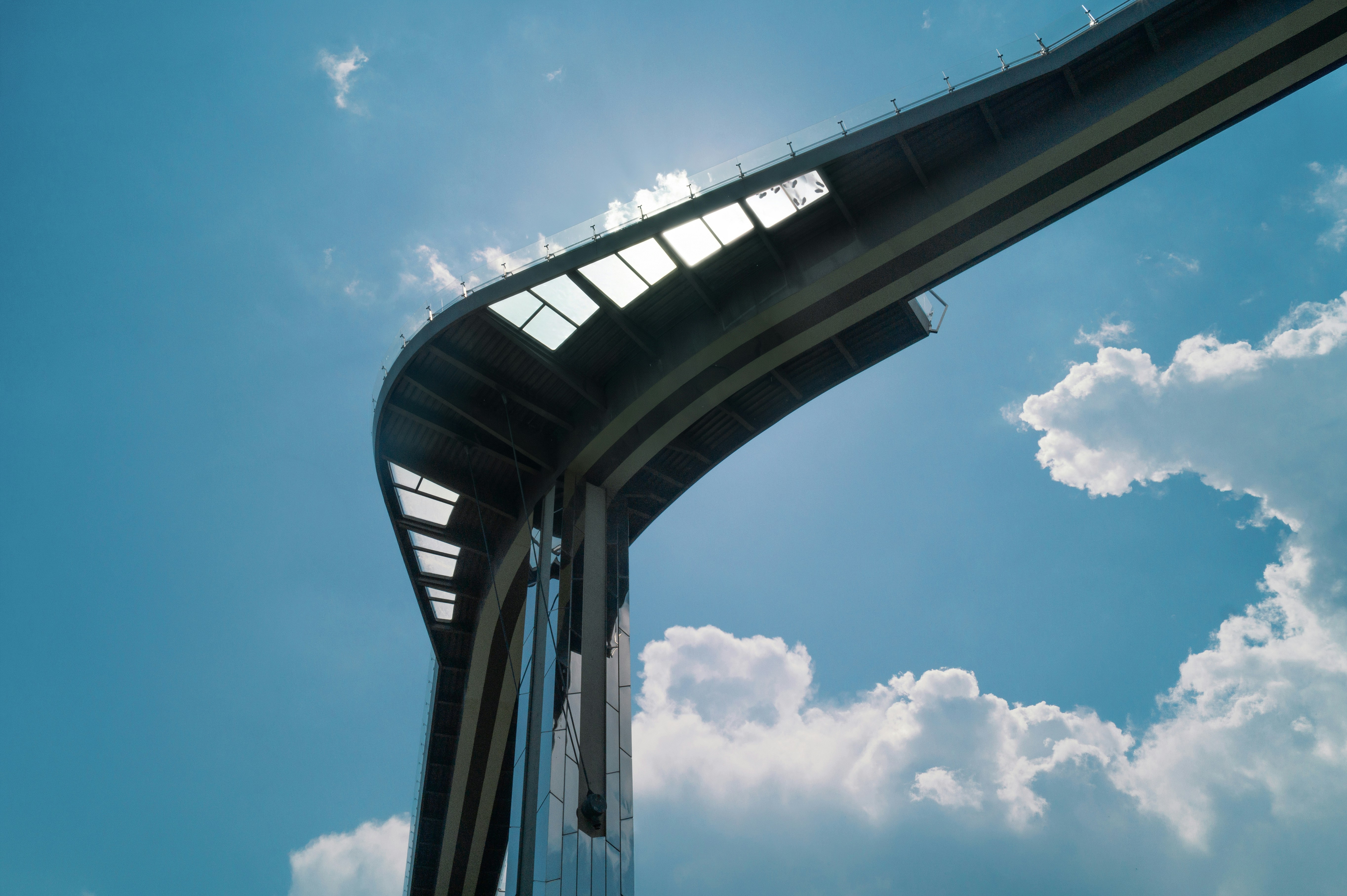 Bridge Curves Into Sky: A Steel Arc Against a Bright Blue