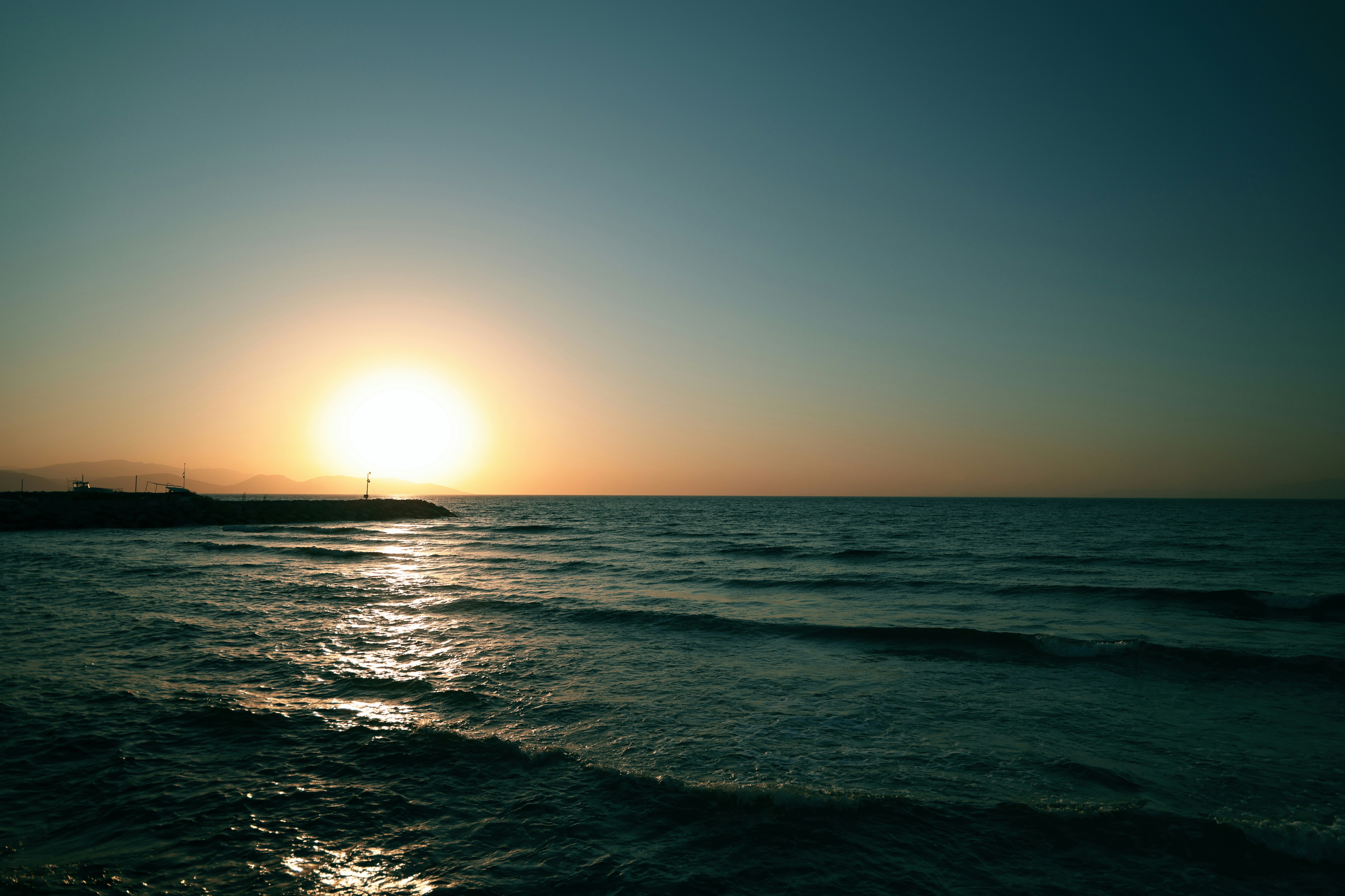 Sunlit Boundary: Horizon Glimmer at Dusk Over Quiet Seas