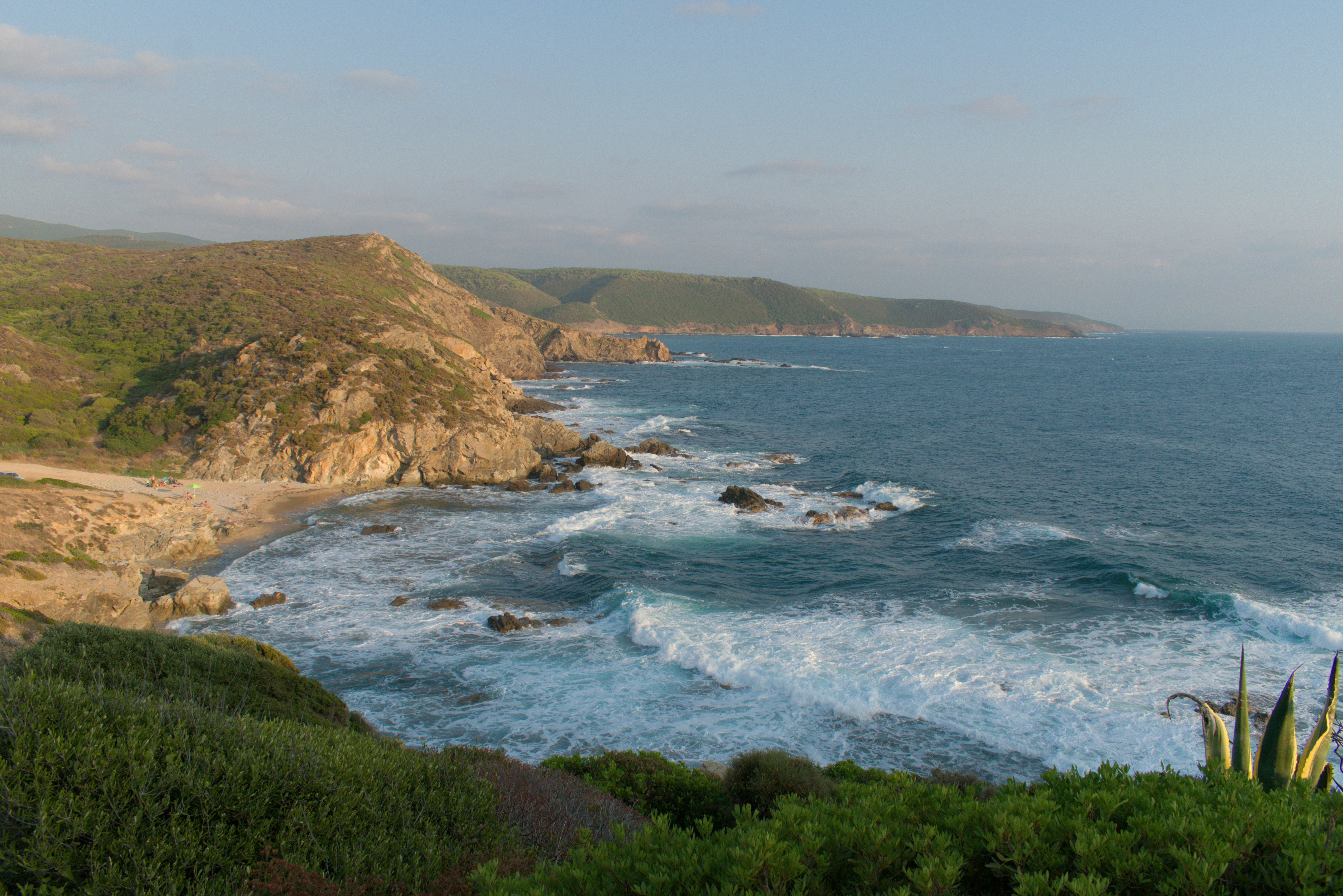 Cliffside Coastline: Waves Crashing Beneath Golden Hills
