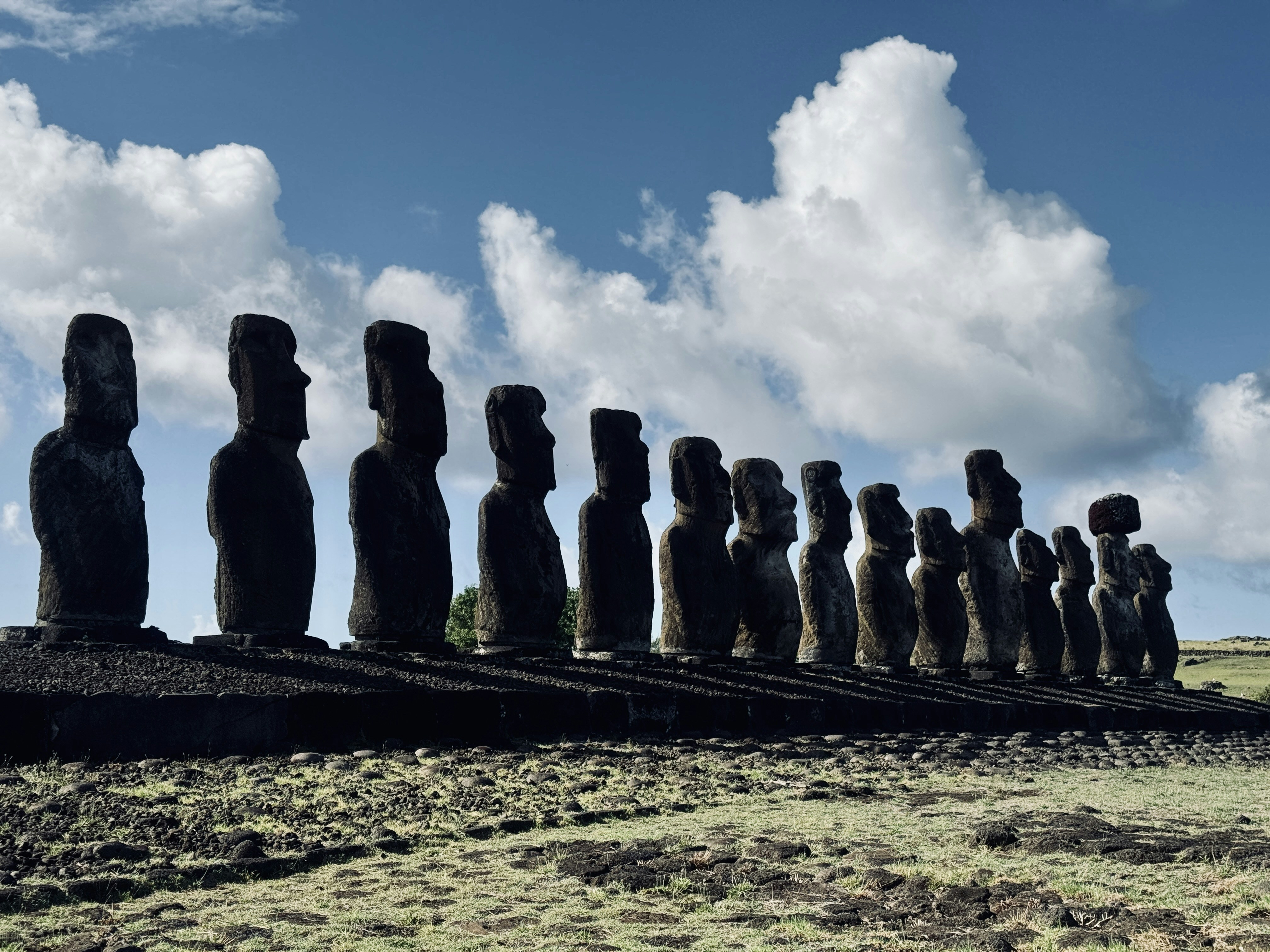 Line of Moai against a windy Atlantic sky
