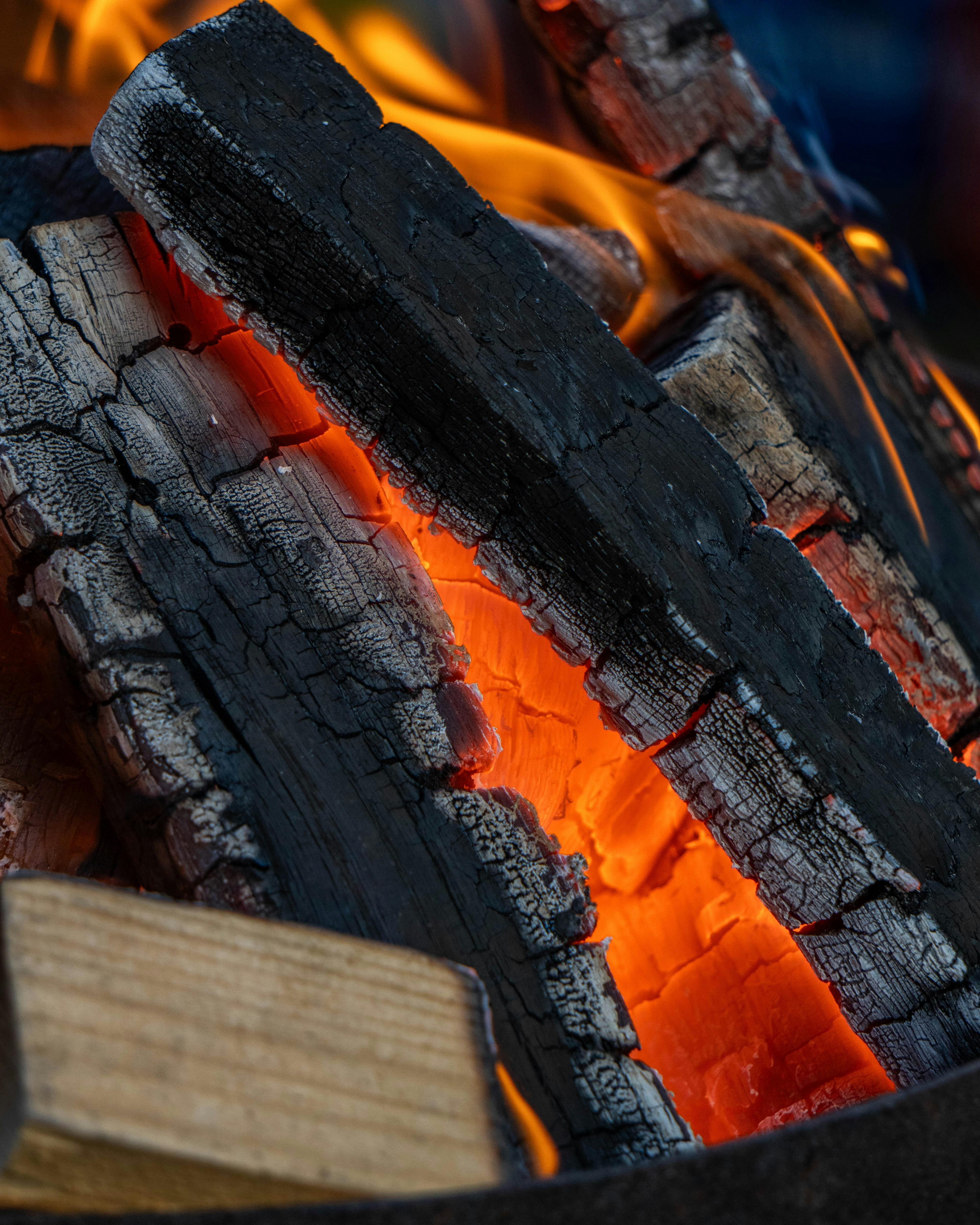 Ember Mosaic: Close-up of Burning Logs with Searing Orange Hues