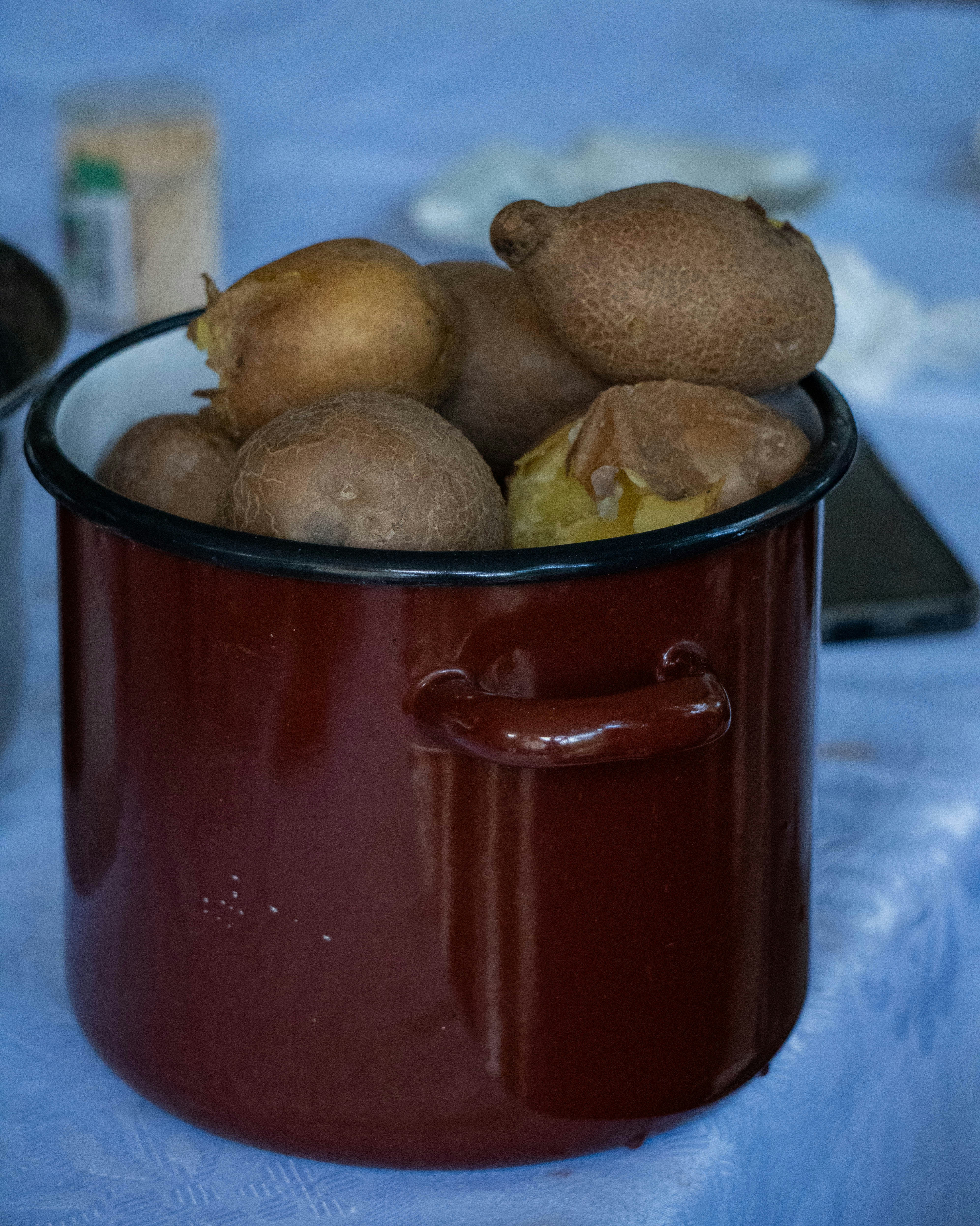 Sourpot Pot: A Rustic Heap of Potatoes in a Deep Maroon Vessel