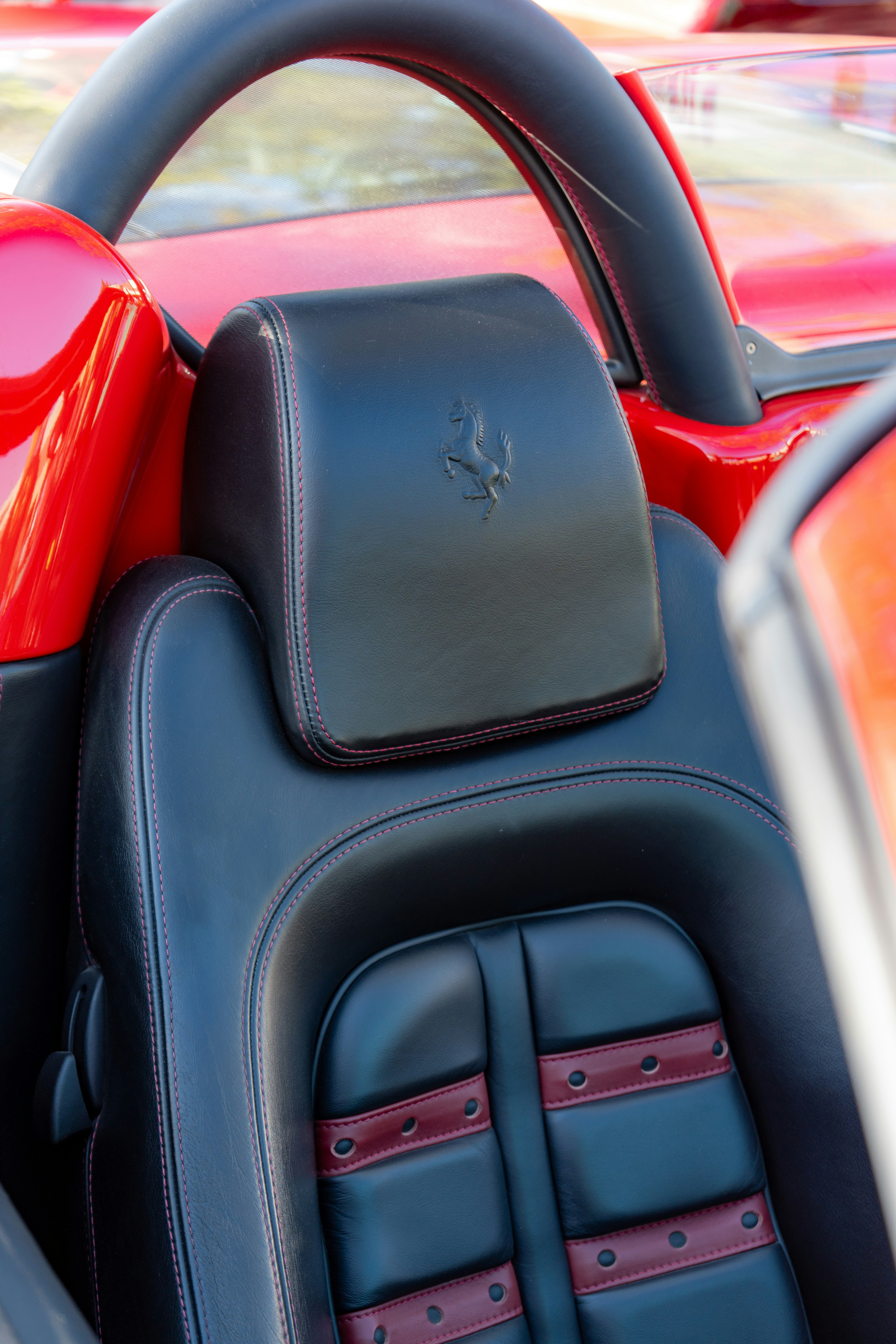 Red Leather Throne: Exposed Ferrari Car Seat Inside a Sport Convertible