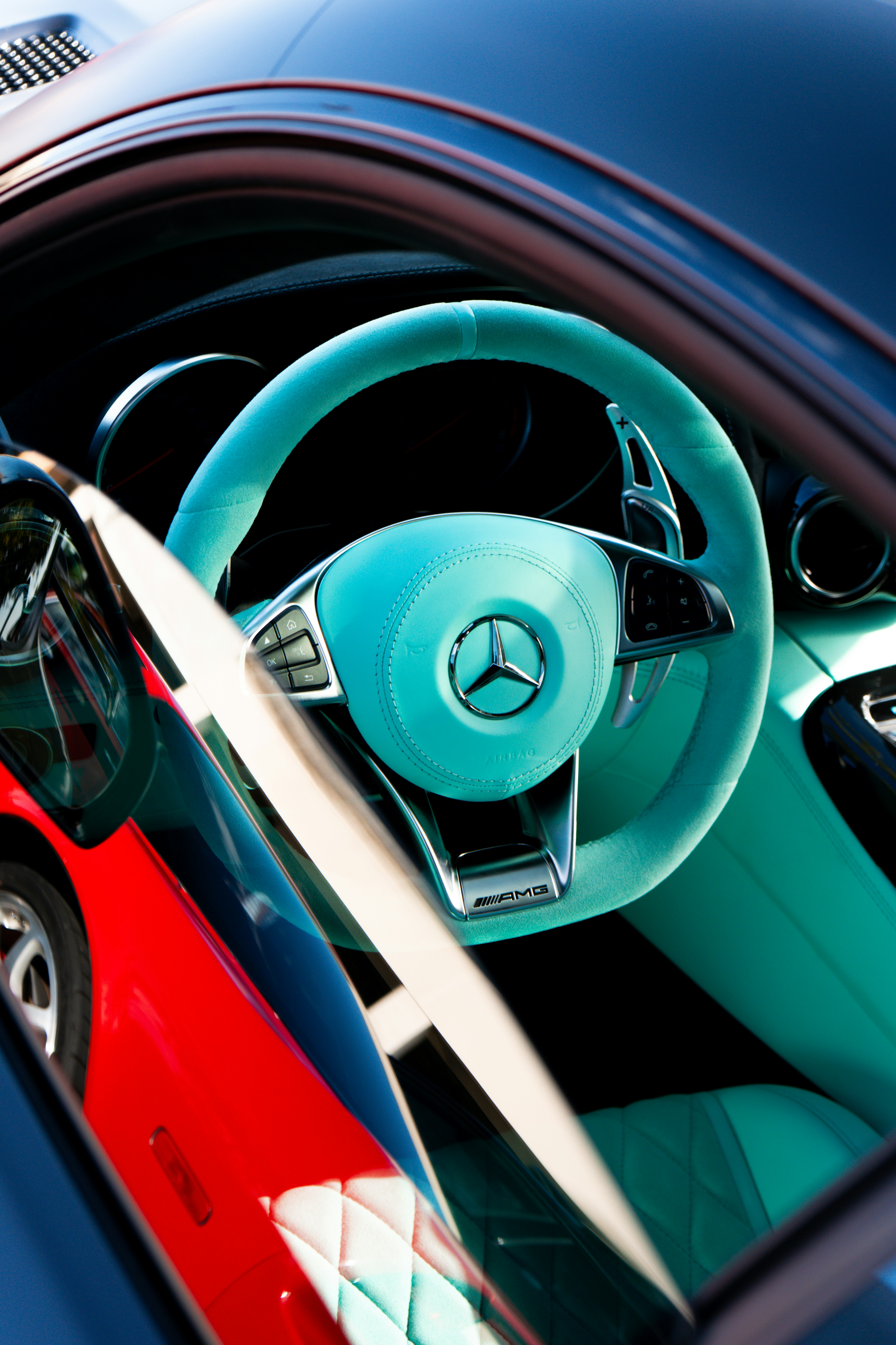 Teal Steering in a Glimmering Mercedes