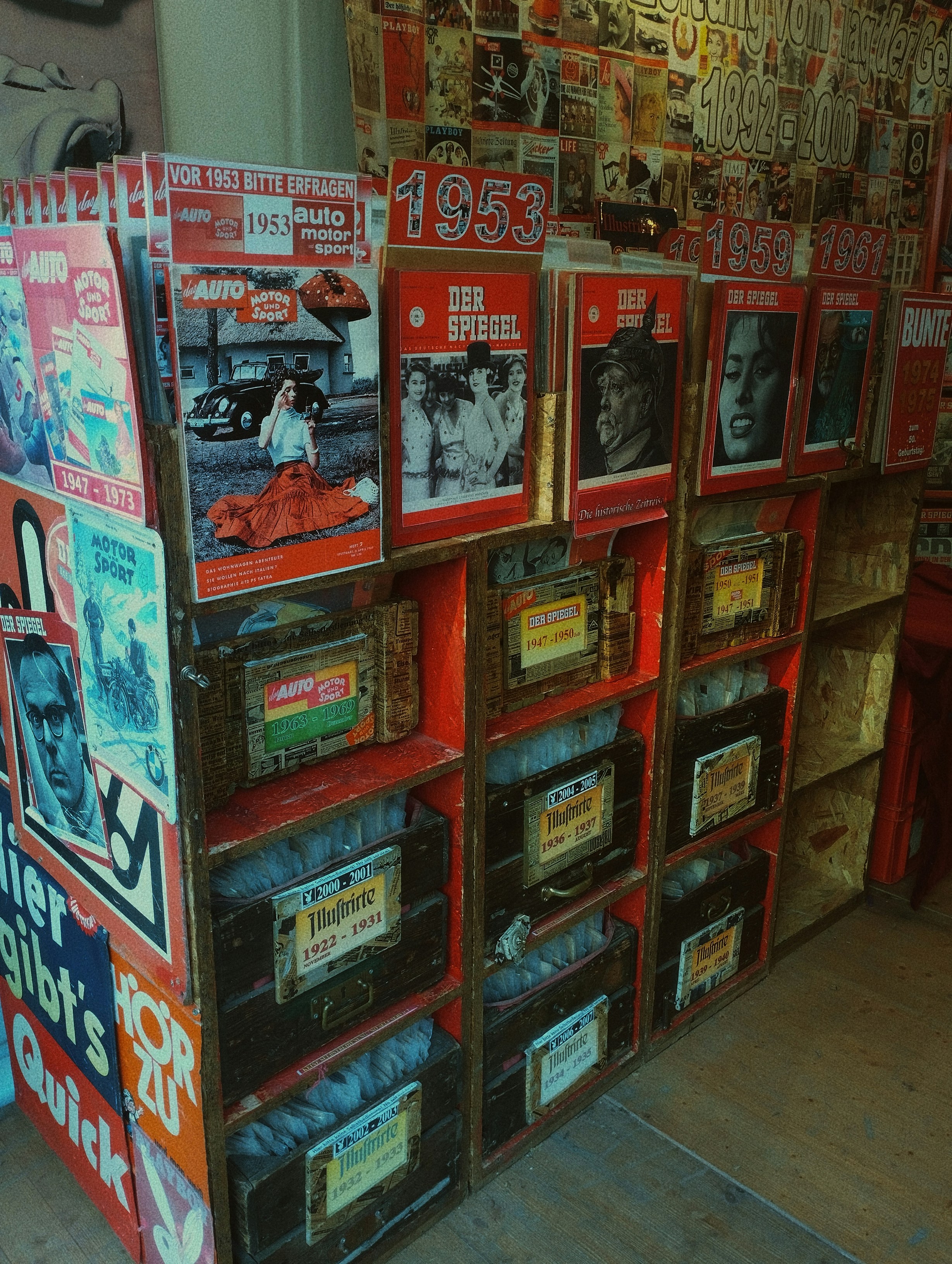 Vintage Magazine Display: A Wall of Time Capsules in Red Shelves
