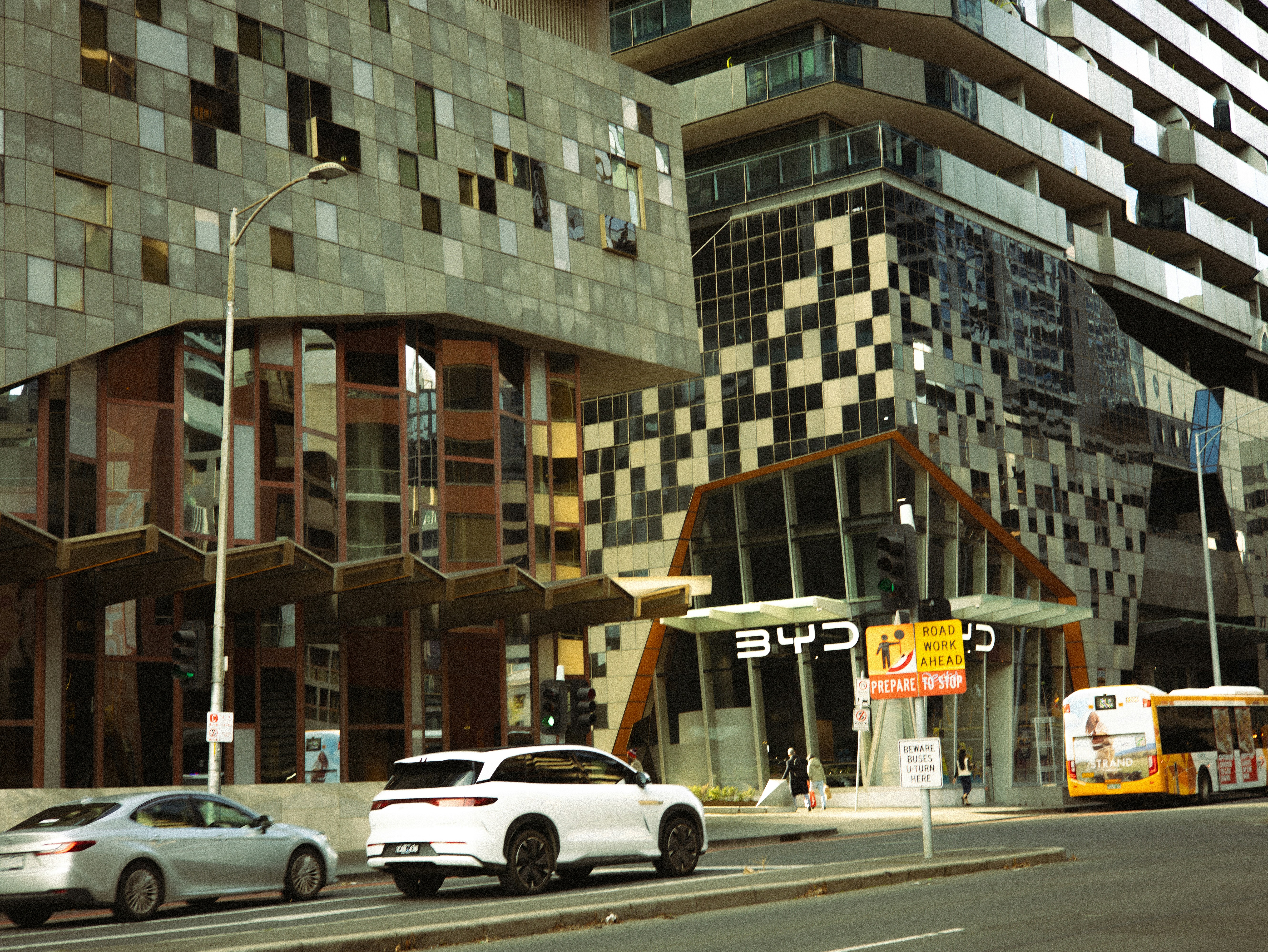 Urban Facade Pulse: Mosaic Glass and Moving Street