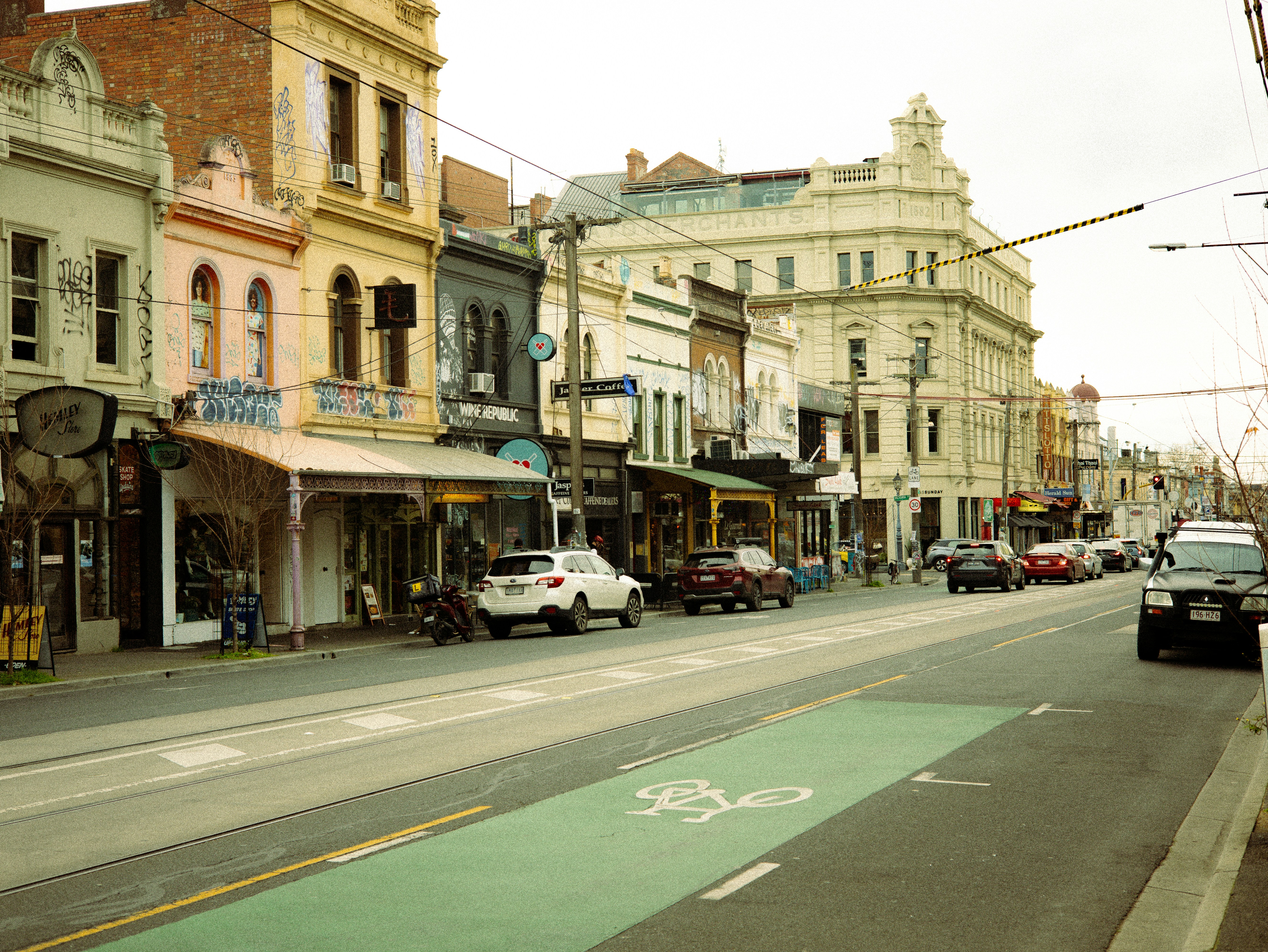 Colorful Main Street: a row of vintage storefronts under a pale sky