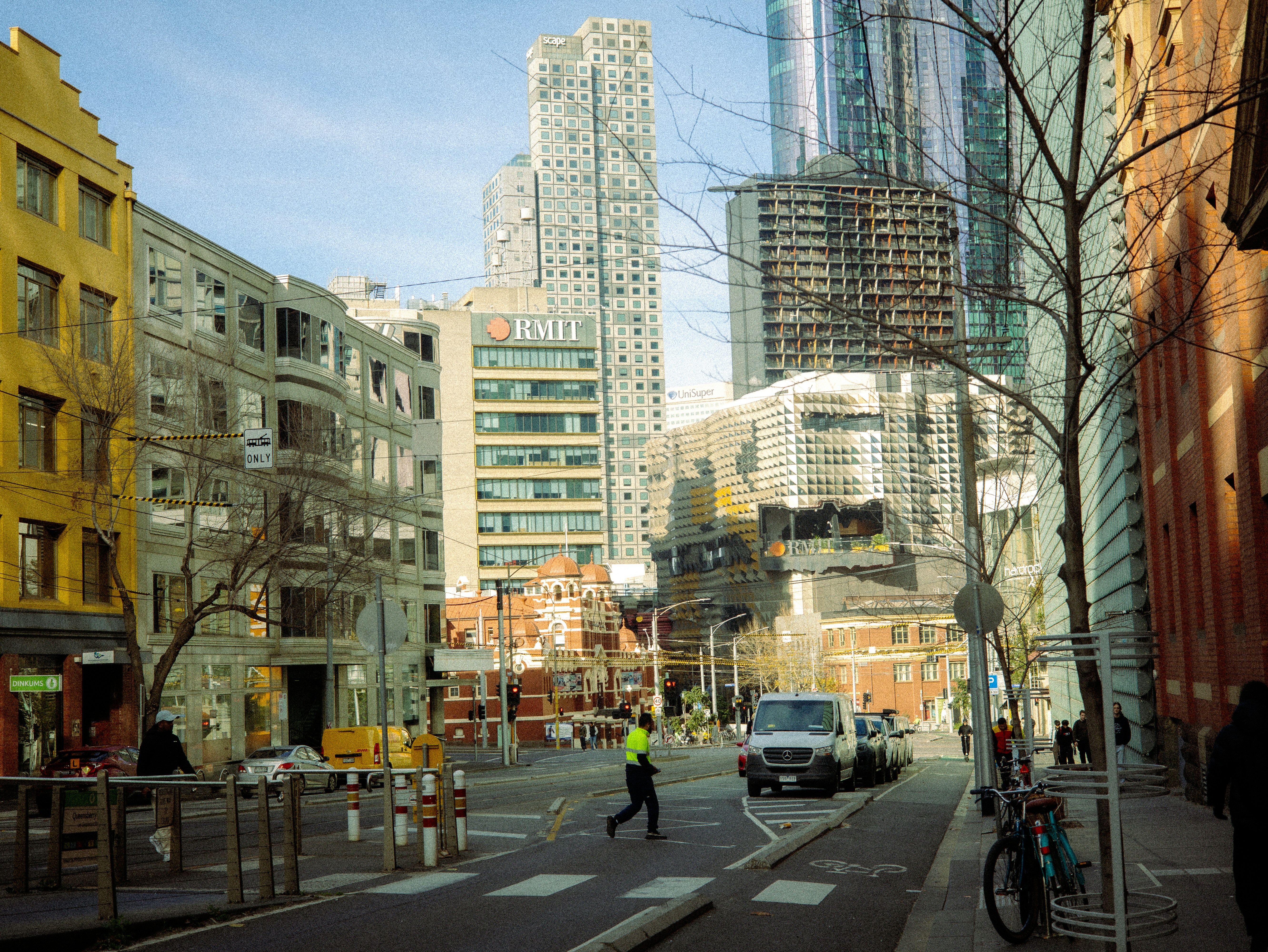 City Street in Motion: A Pedestrian Crossing Beneath Modern Towers