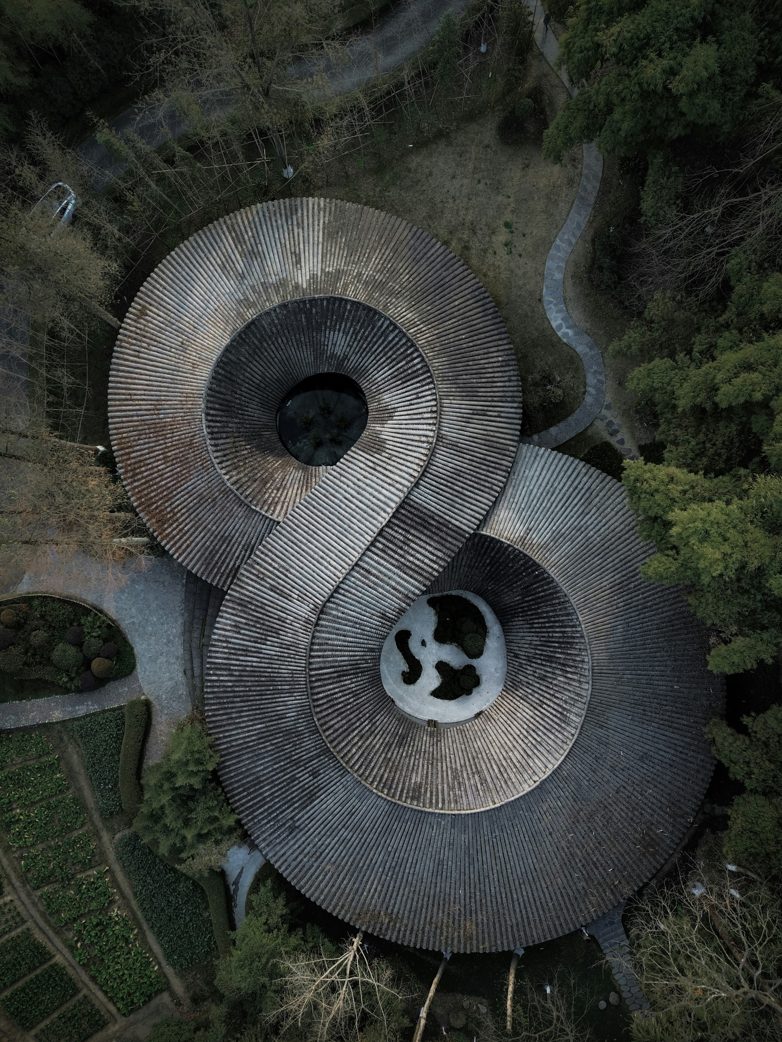 Circular Labyrinth: Aerial View of Interwoven Wooden Spiral Walkways