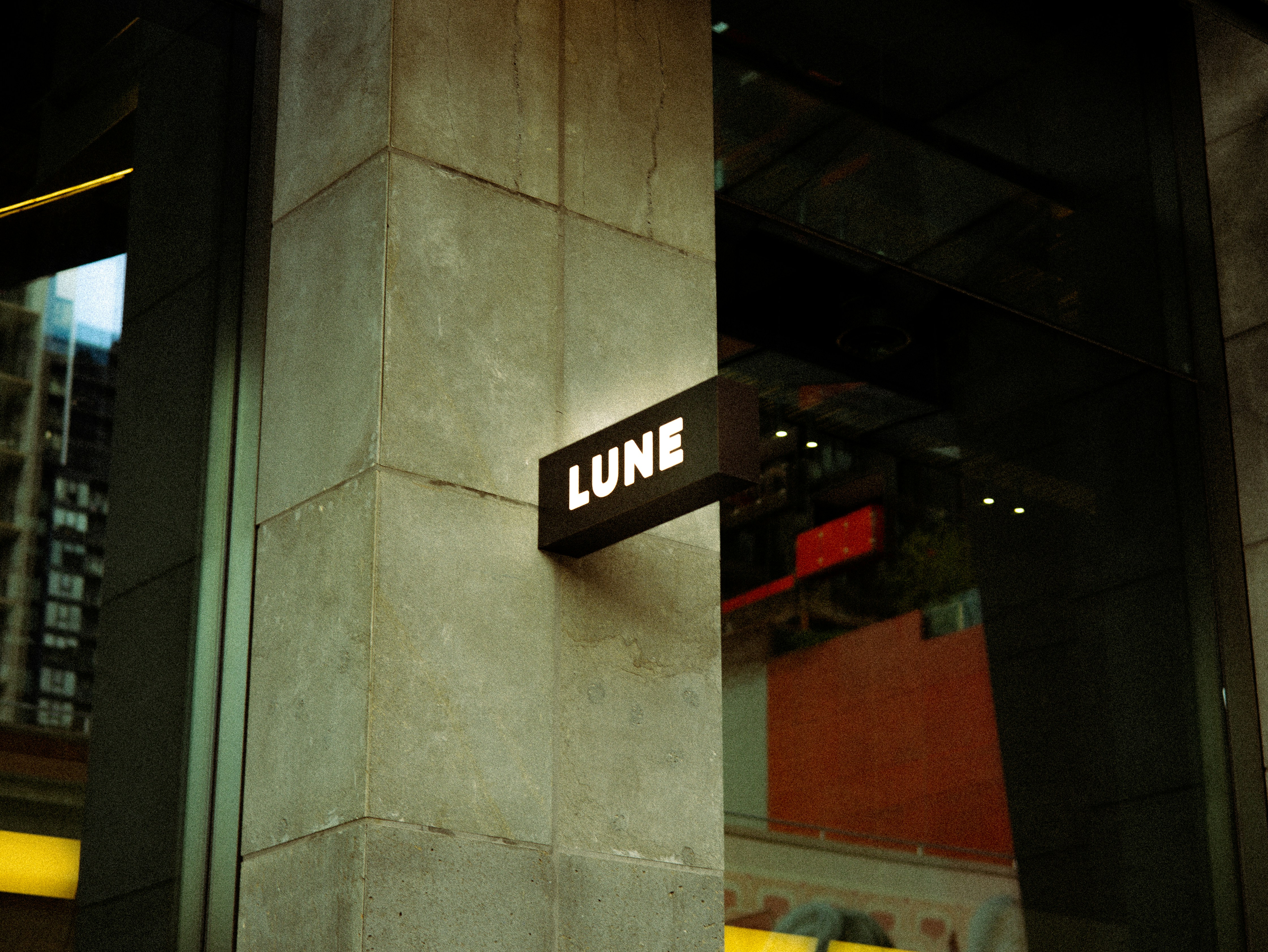 LUNE Neon Sign Adorning a Stone Facade