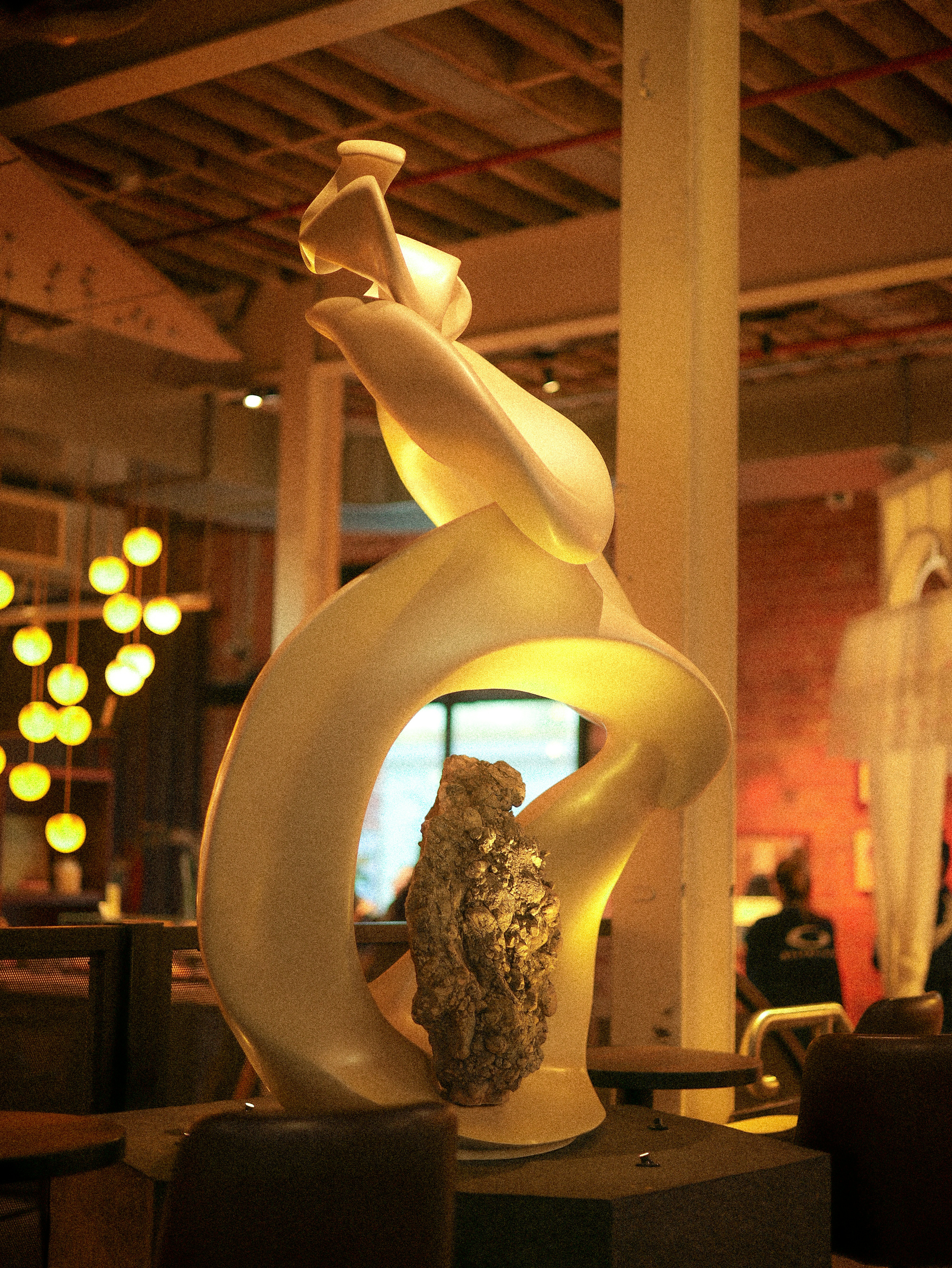 Twisted Marble: A Sculpted Flame Amid Warm Industrial Light