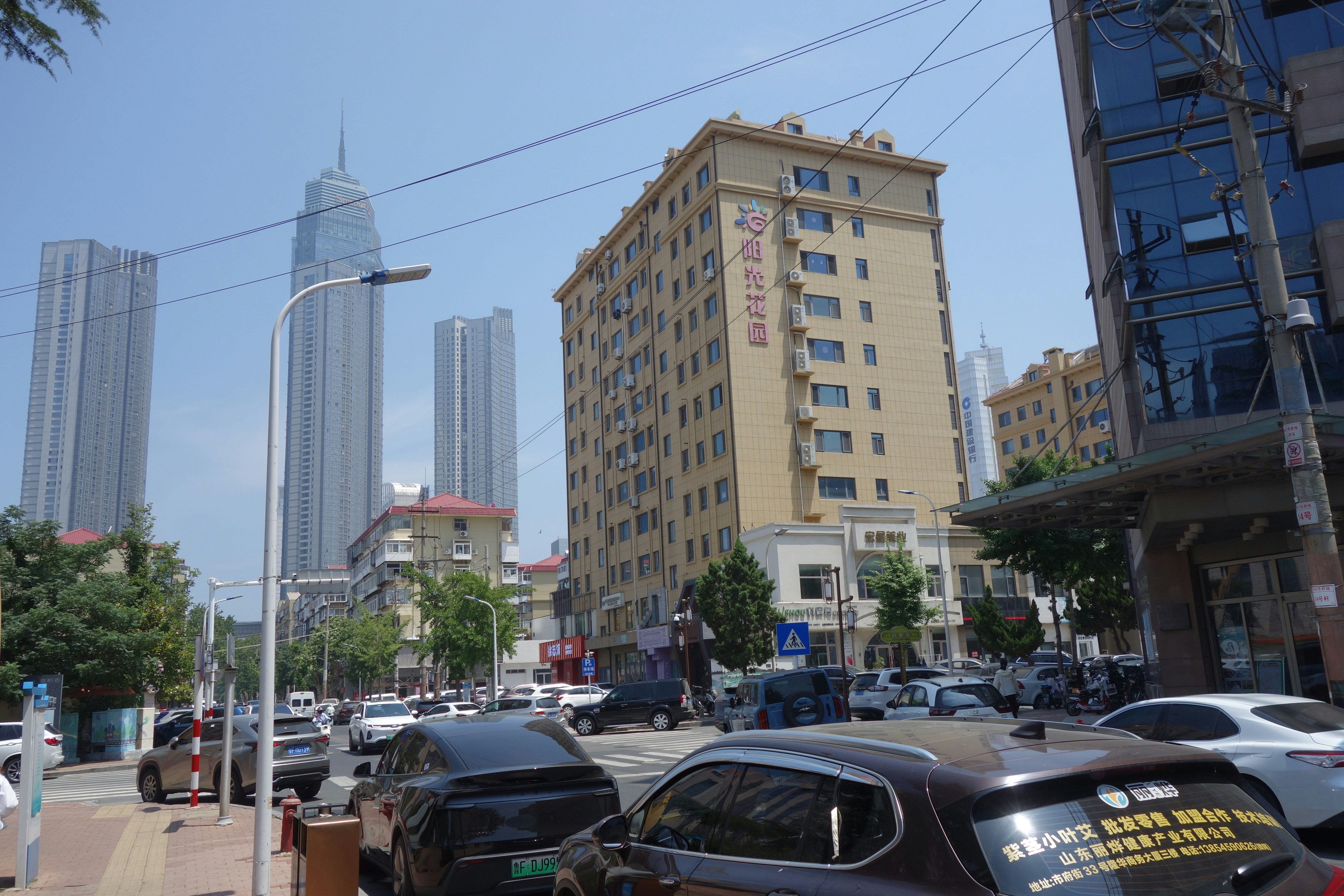 Urban Convergence: Glass Towers Over a Bustling Street