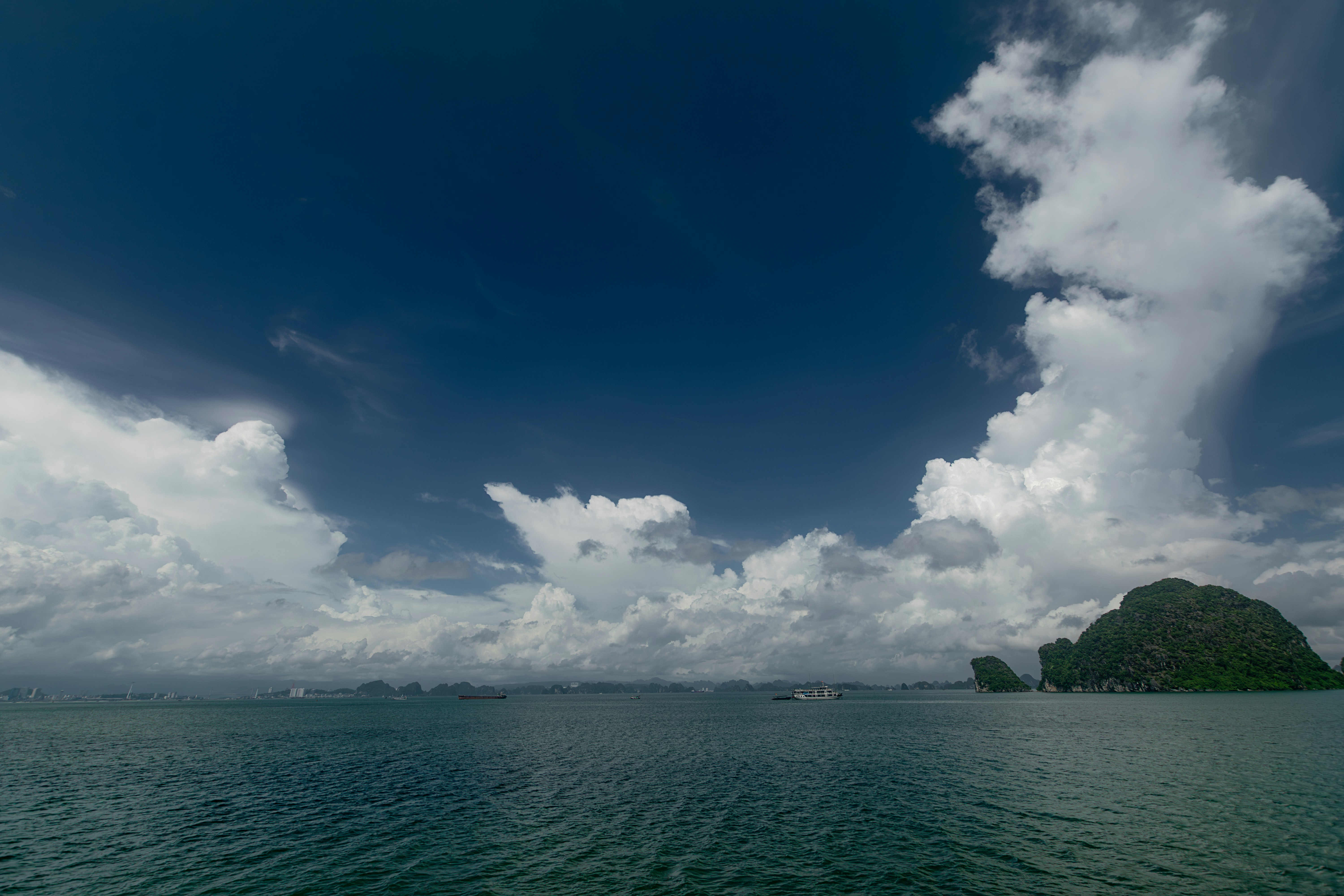 Midday Horizon over Quiet Blue Waters with Distant Islands