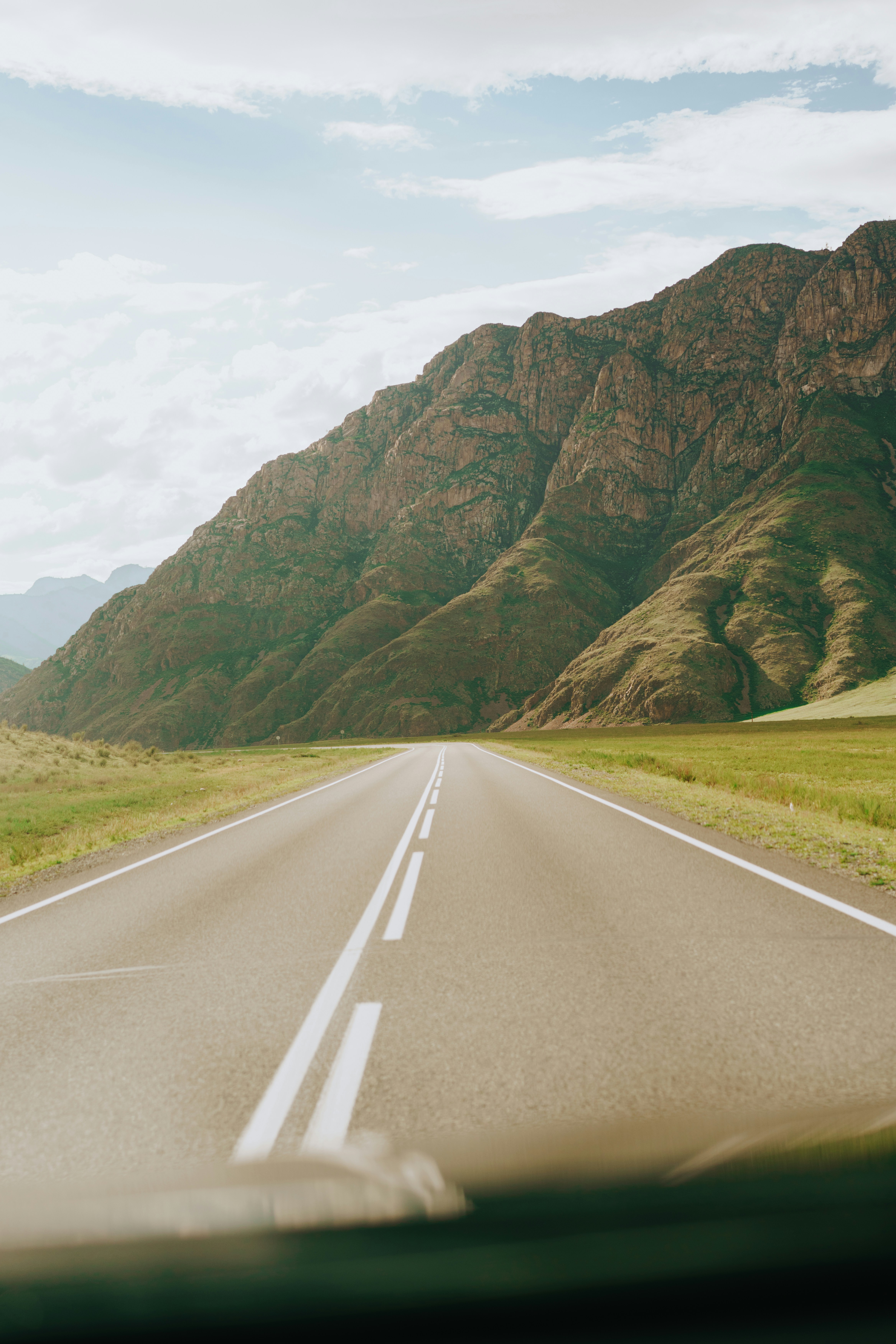 A Desolate Highway Carves Through Majestic Peaks