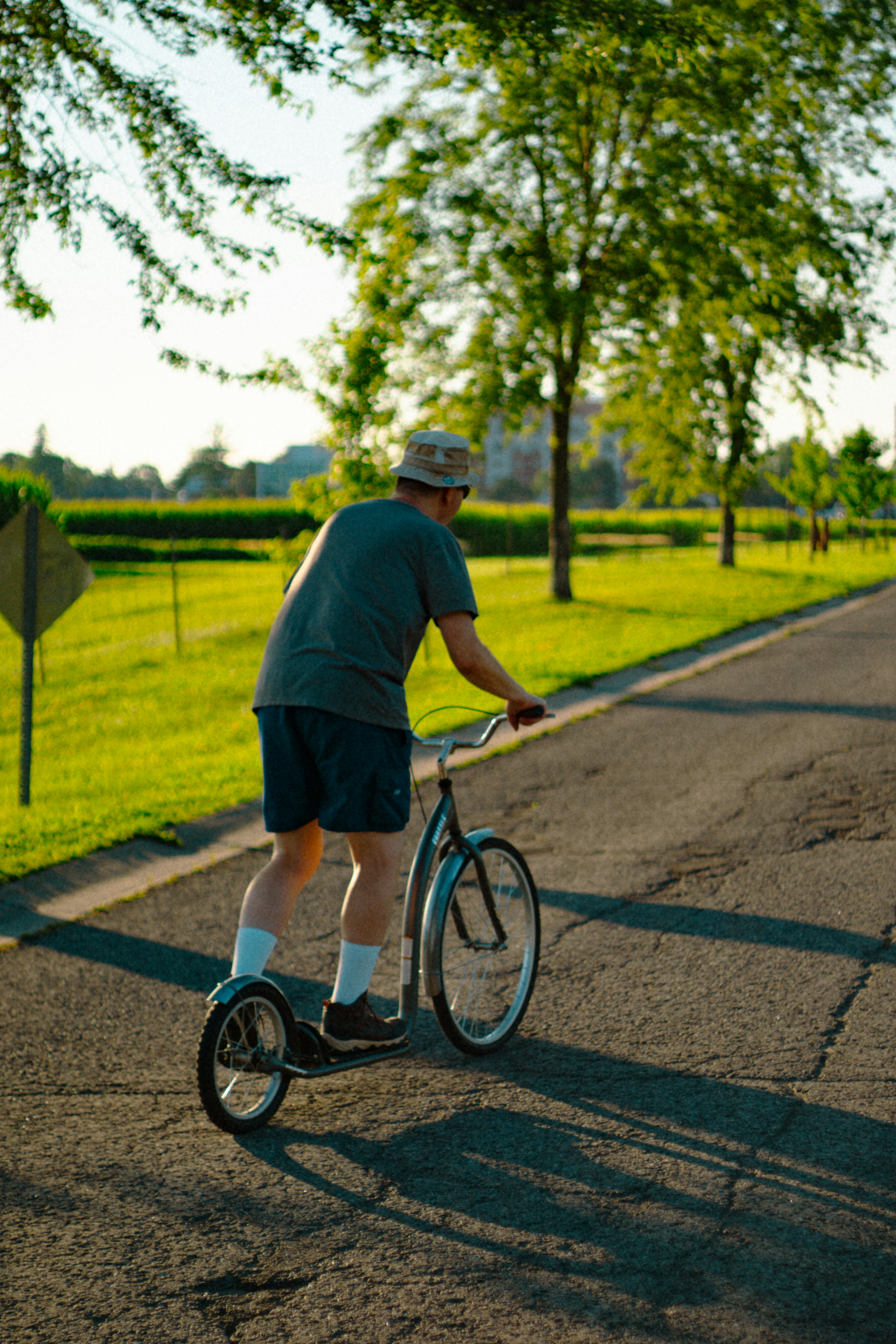 Sunlit Ride: A Quiet Moment on the Neighborhood Scooter