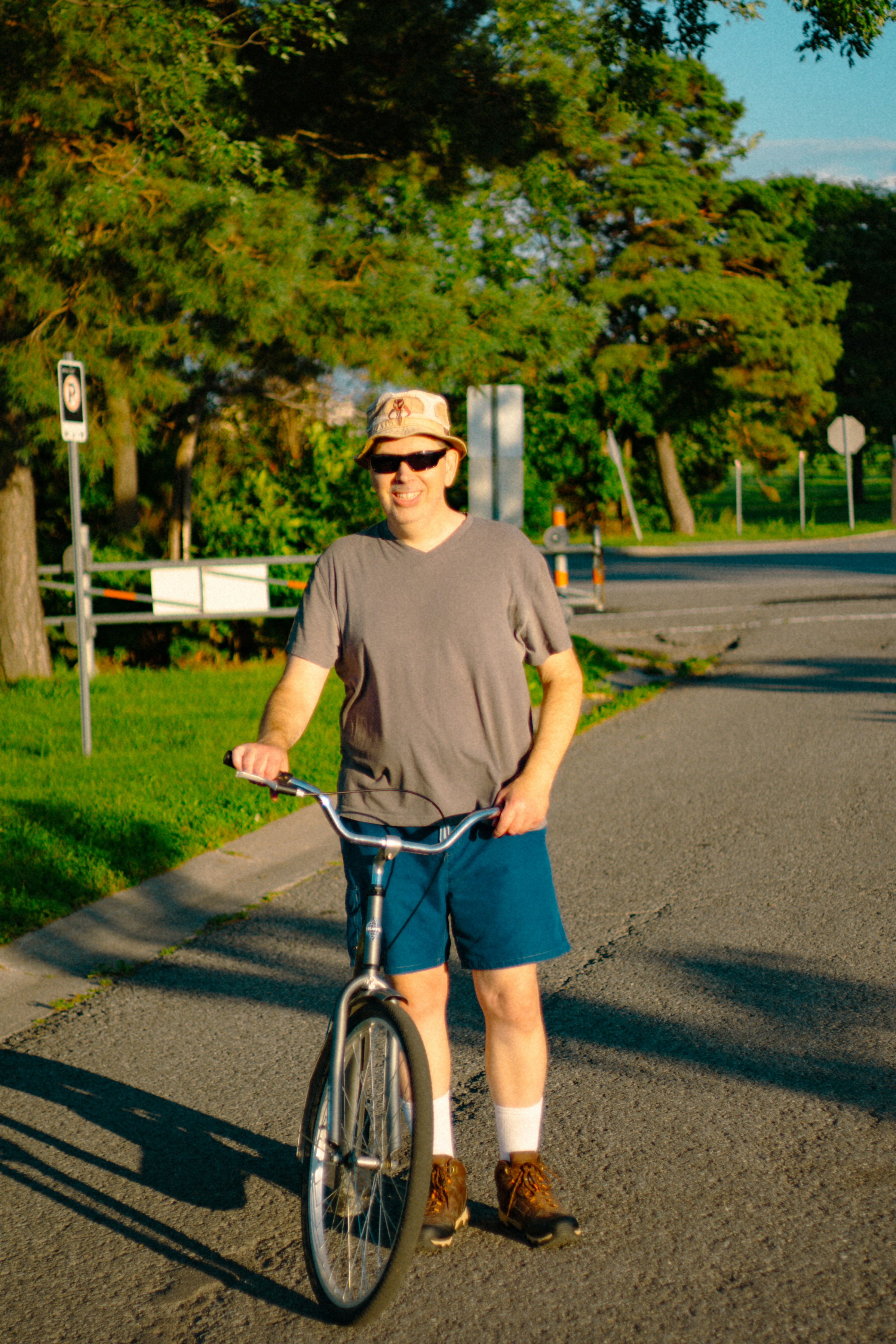Smiling Cyclist at Dappled Park Edge