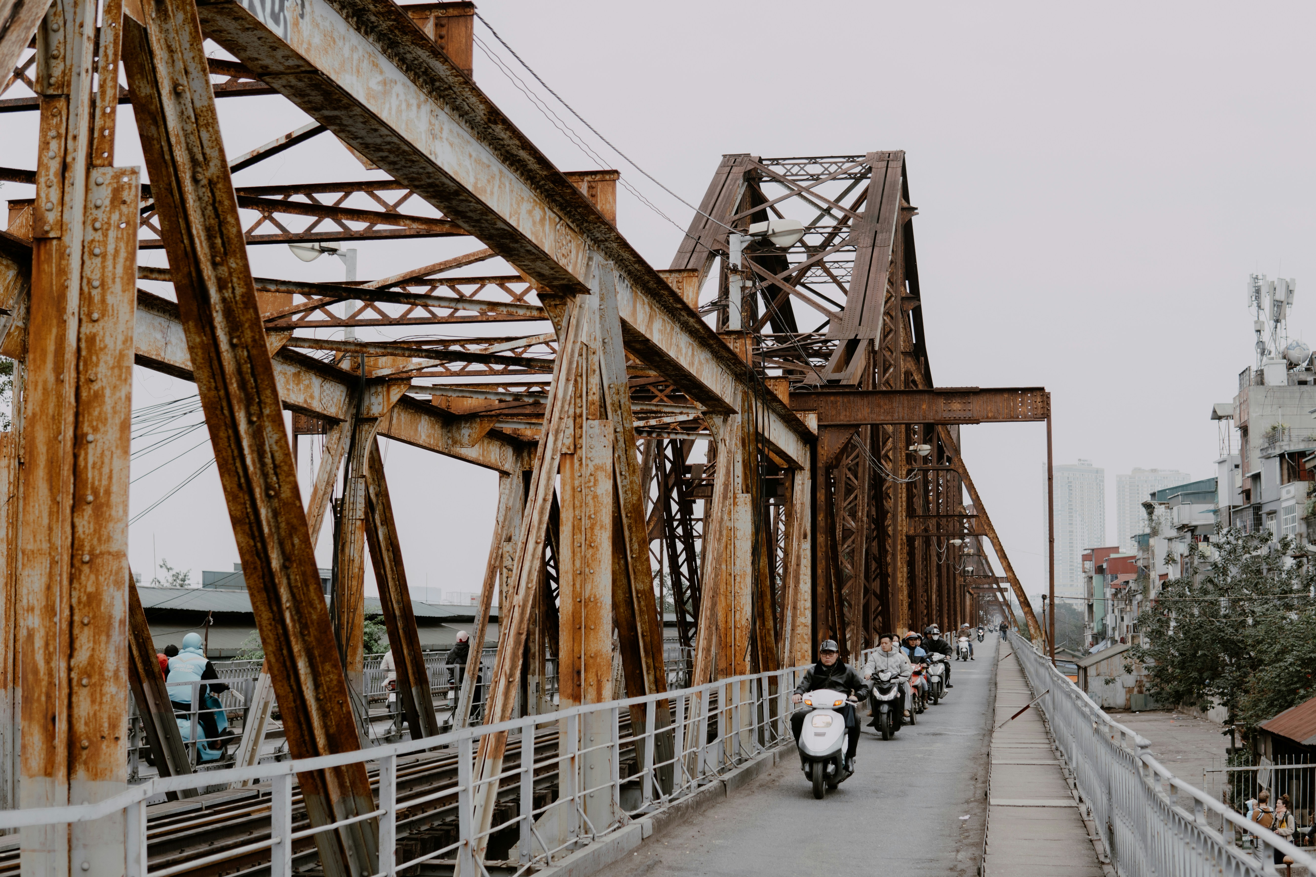 Rusted Iron Path: A Motorbike Row on a Weathered Bridge