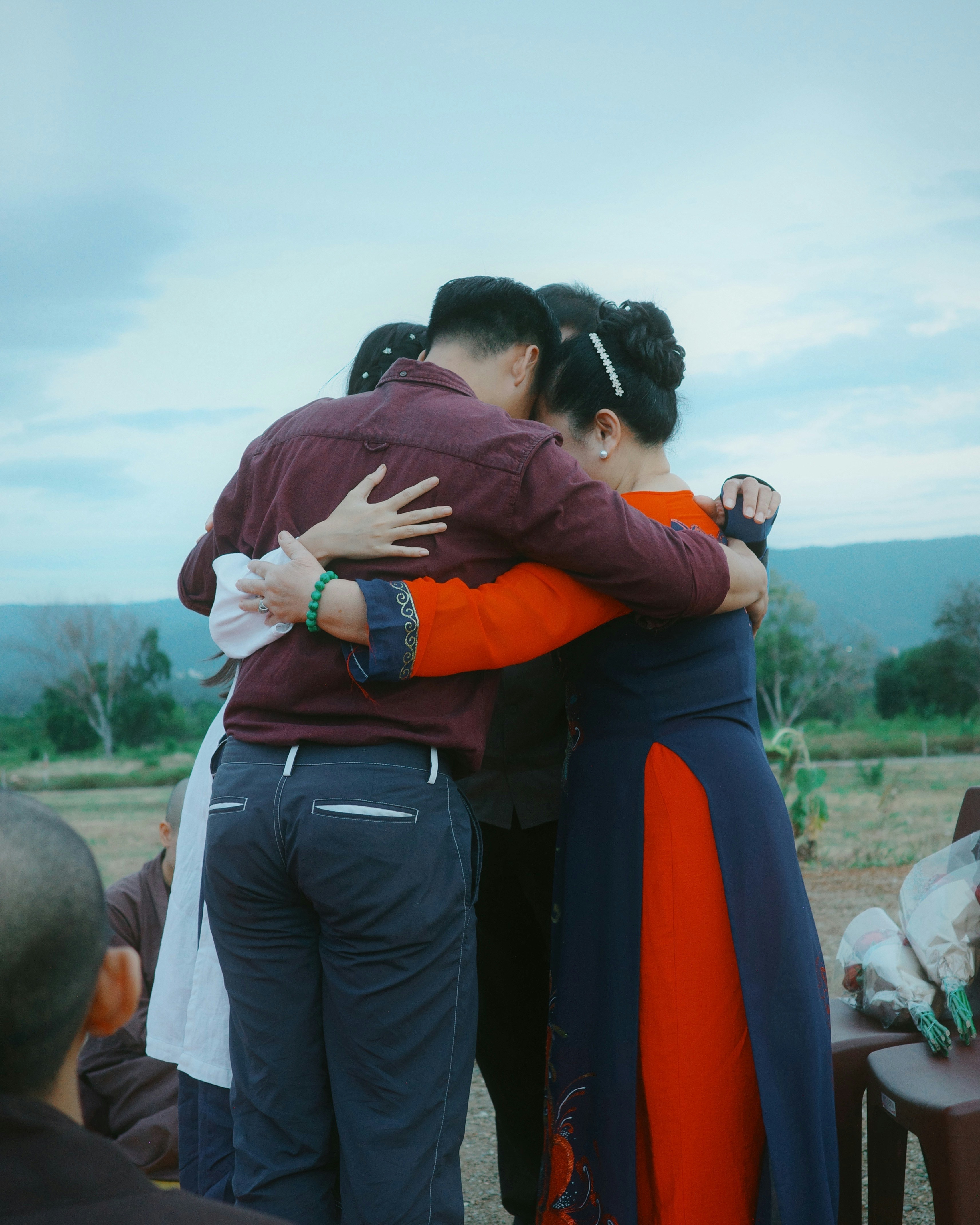 Hugging in a Sunny Field: A Moment of Reunion