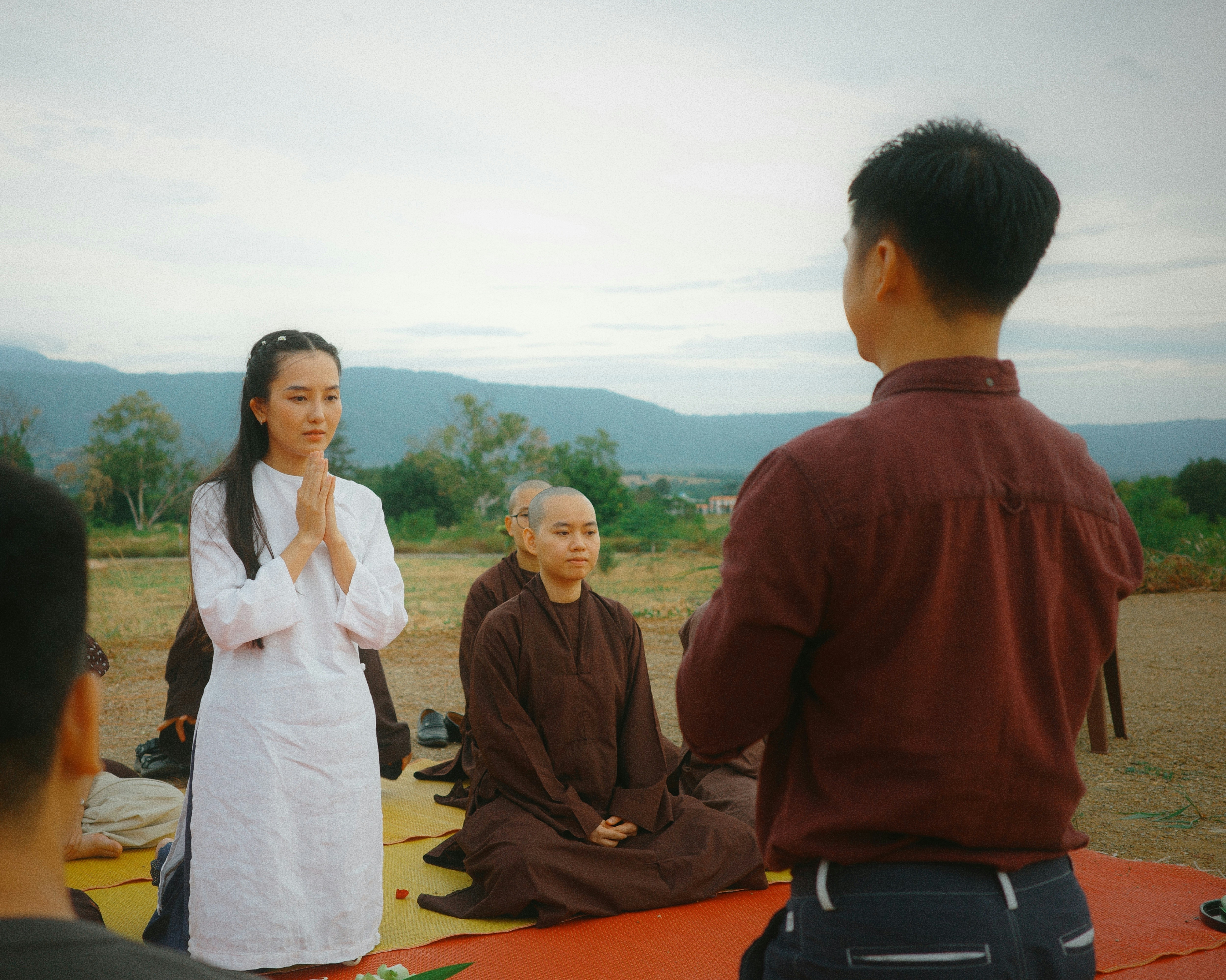 Quiet Teaching Moment: Monks and a Listener in an Open Field