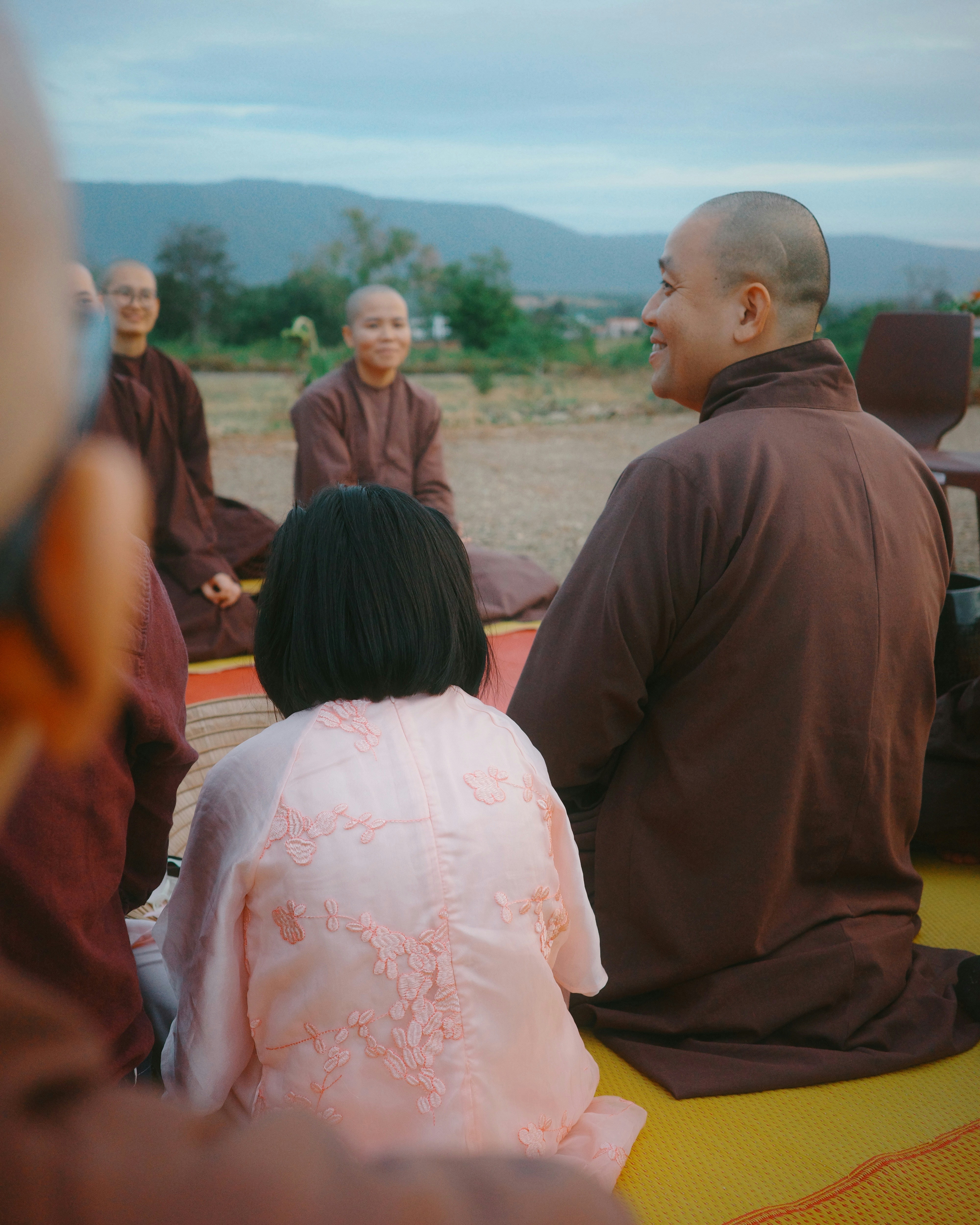 Quiet Gathered Moment: Monks in Soft Evening Light