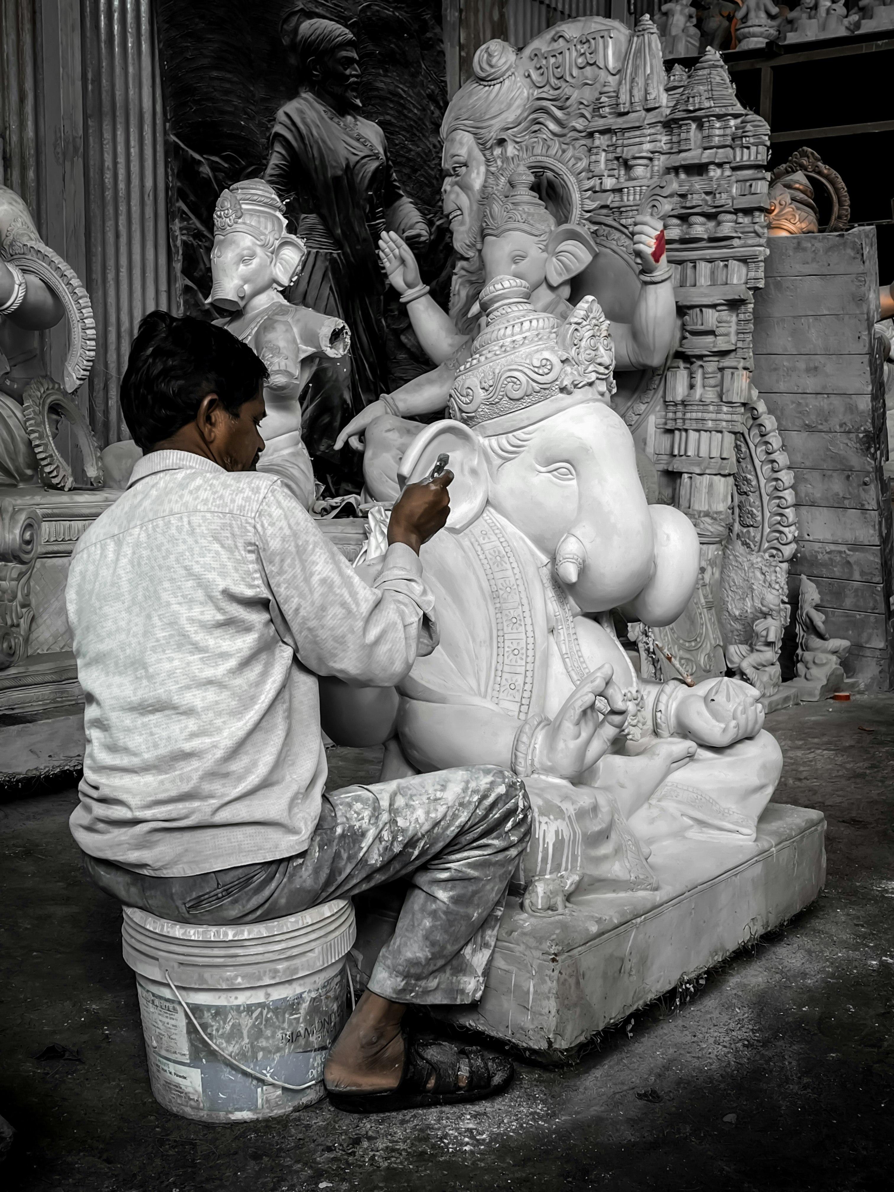 Carving Focus: hands, chisel, and statue in progress