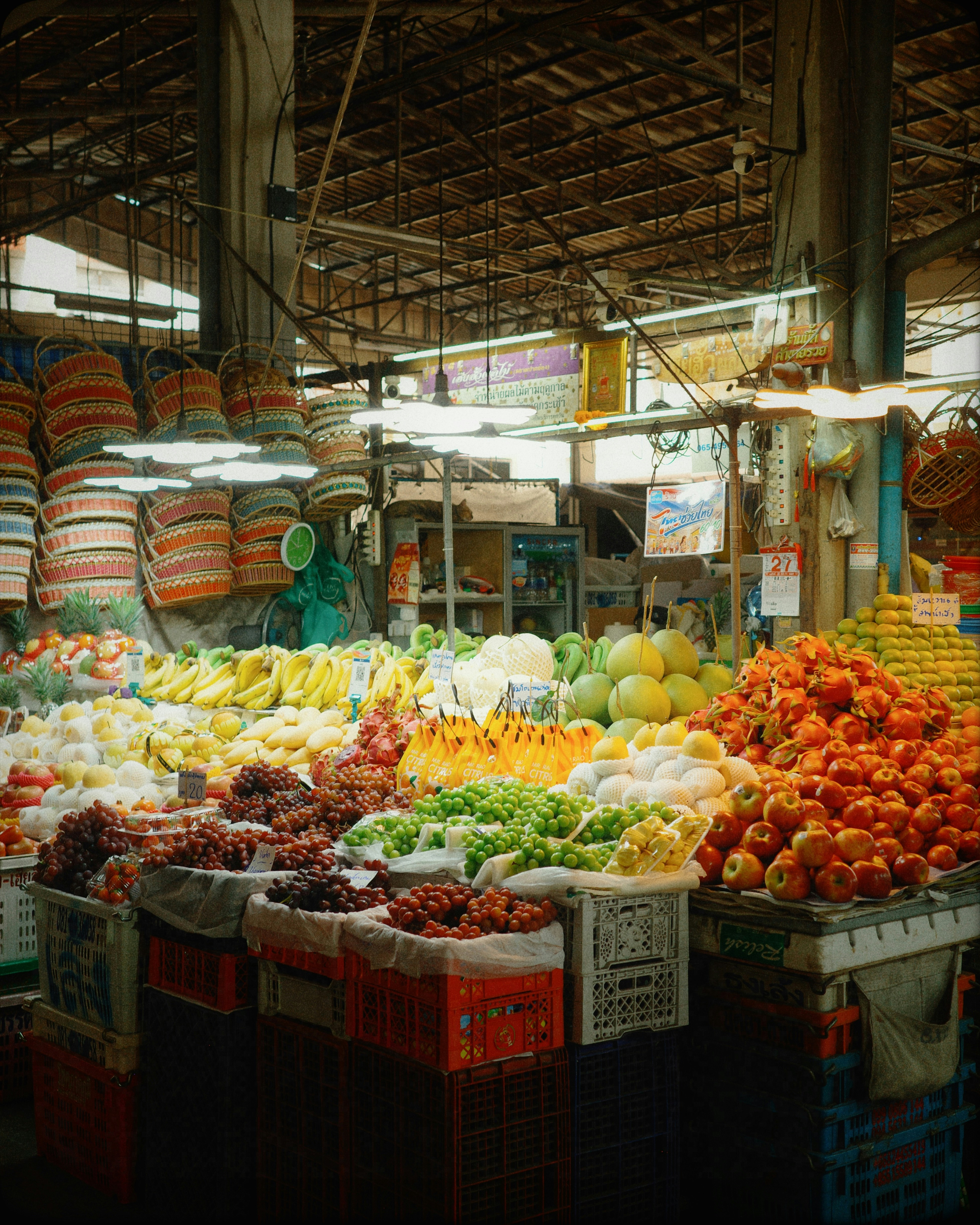 Vibrant Market Carousel: Fresh Fruit & Colorful Bounty Under Warm Lights