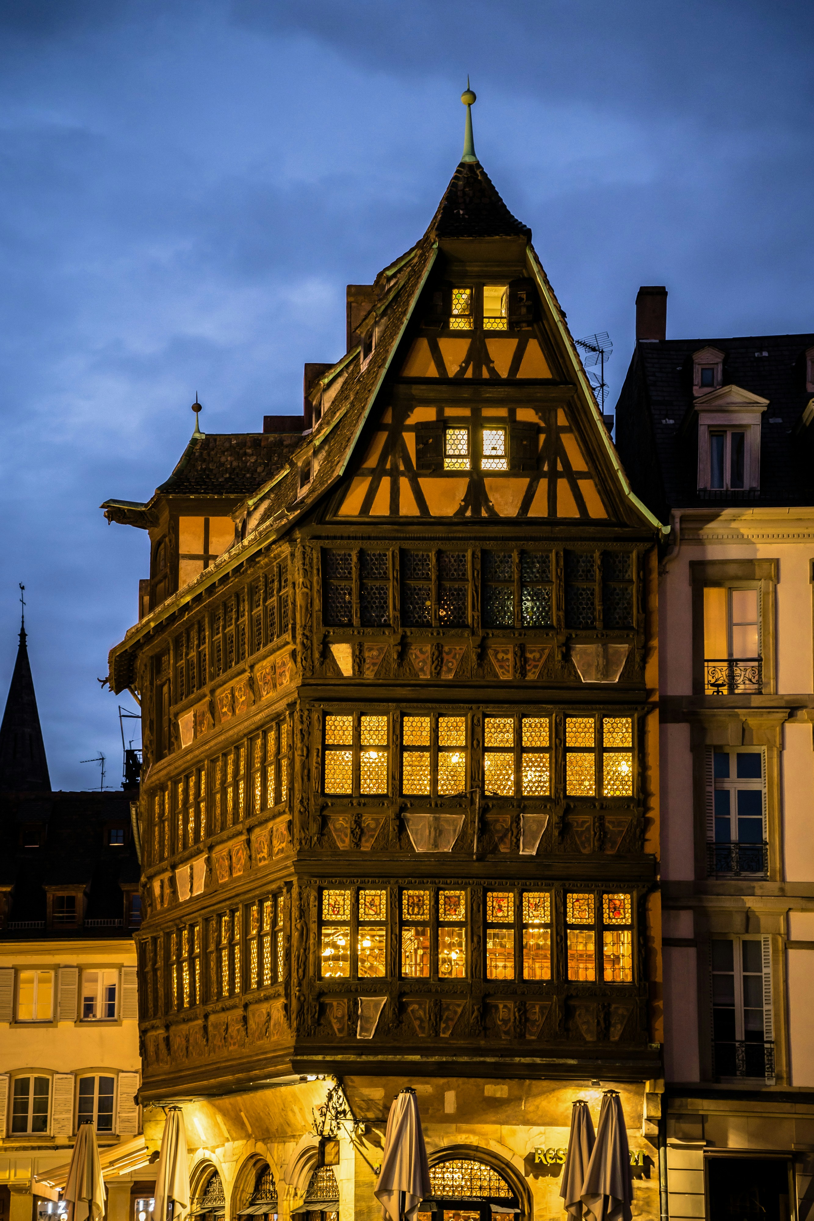 Timbered Façade at Dusk: A Warm Glimmer on a Medieval Street