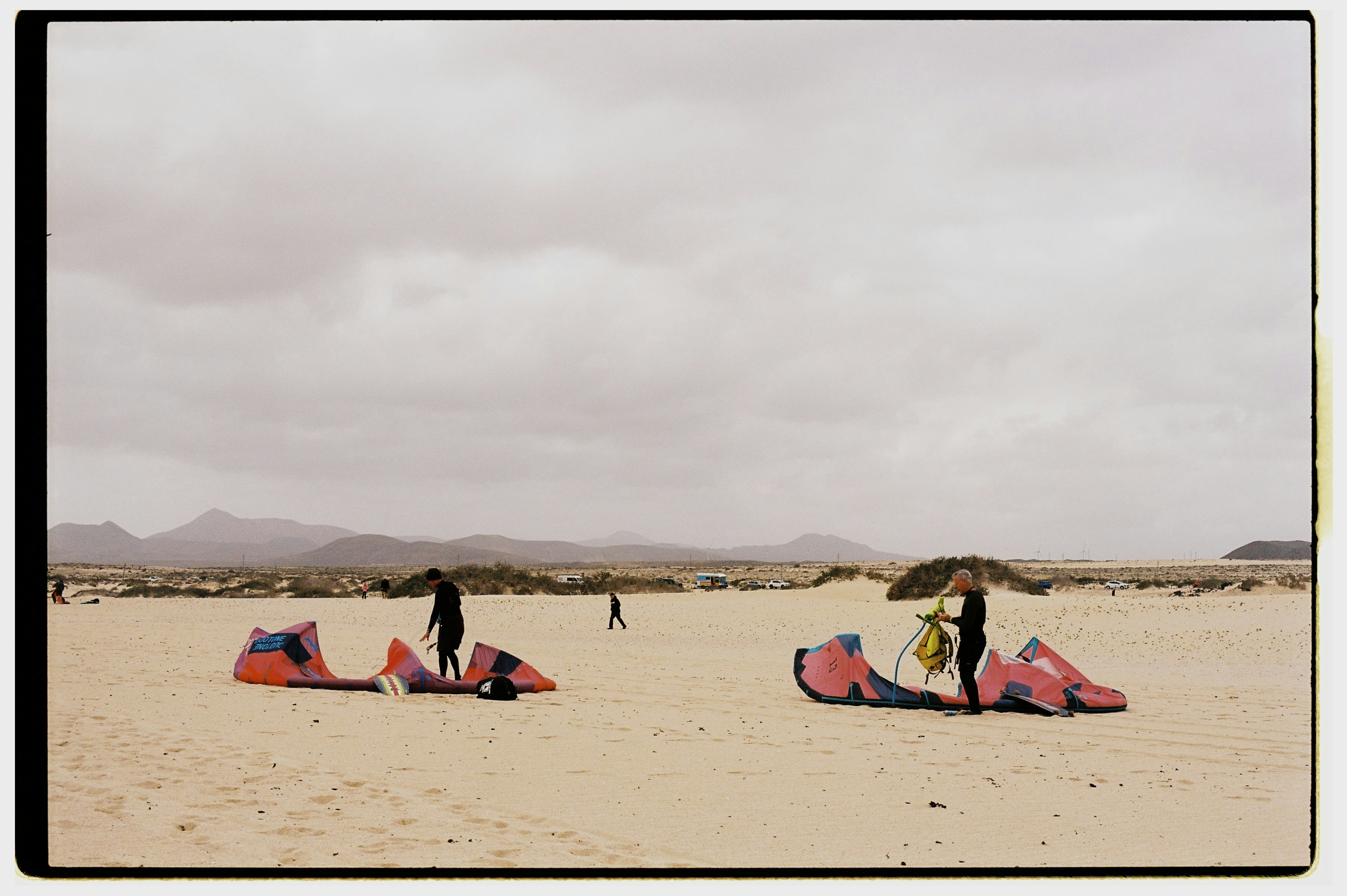 Ventures on the Dune: Kite Surfers Rest on a Quiet Desert Beach