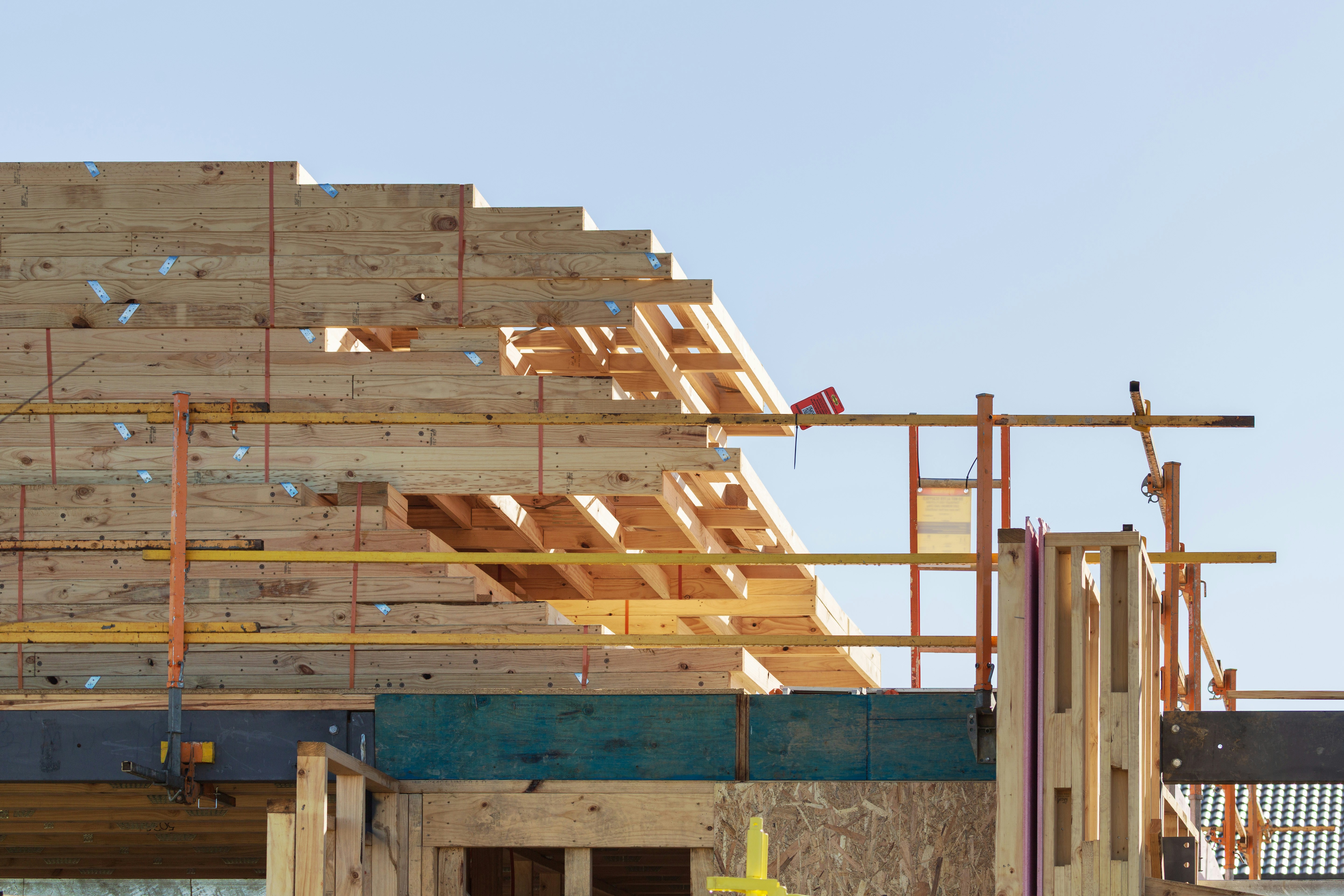 Wooden Framework Rises: A Construction Skeleton Under Open Sky