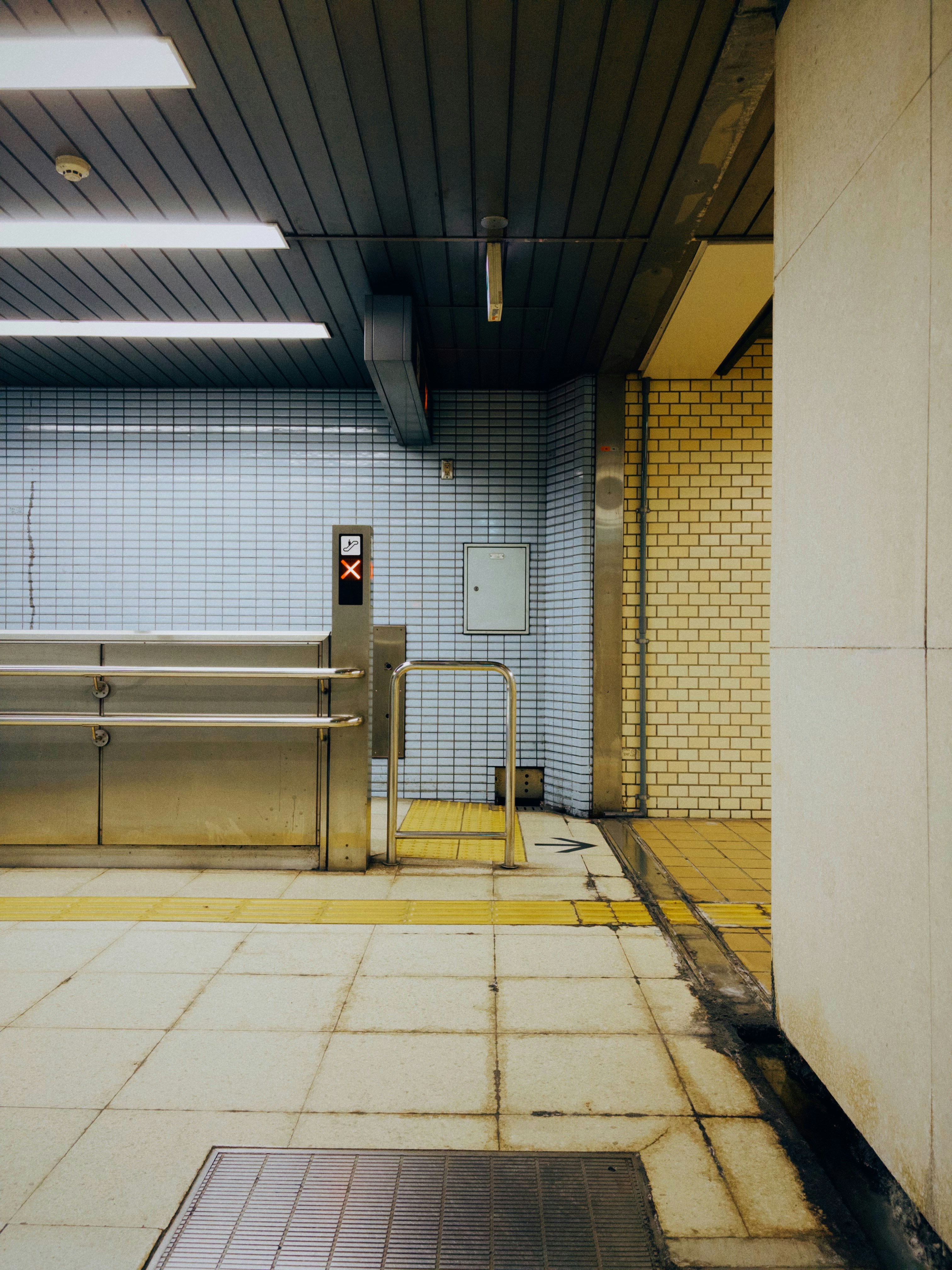 Subway Threshold: Quiet Corridor of Tiles and Light