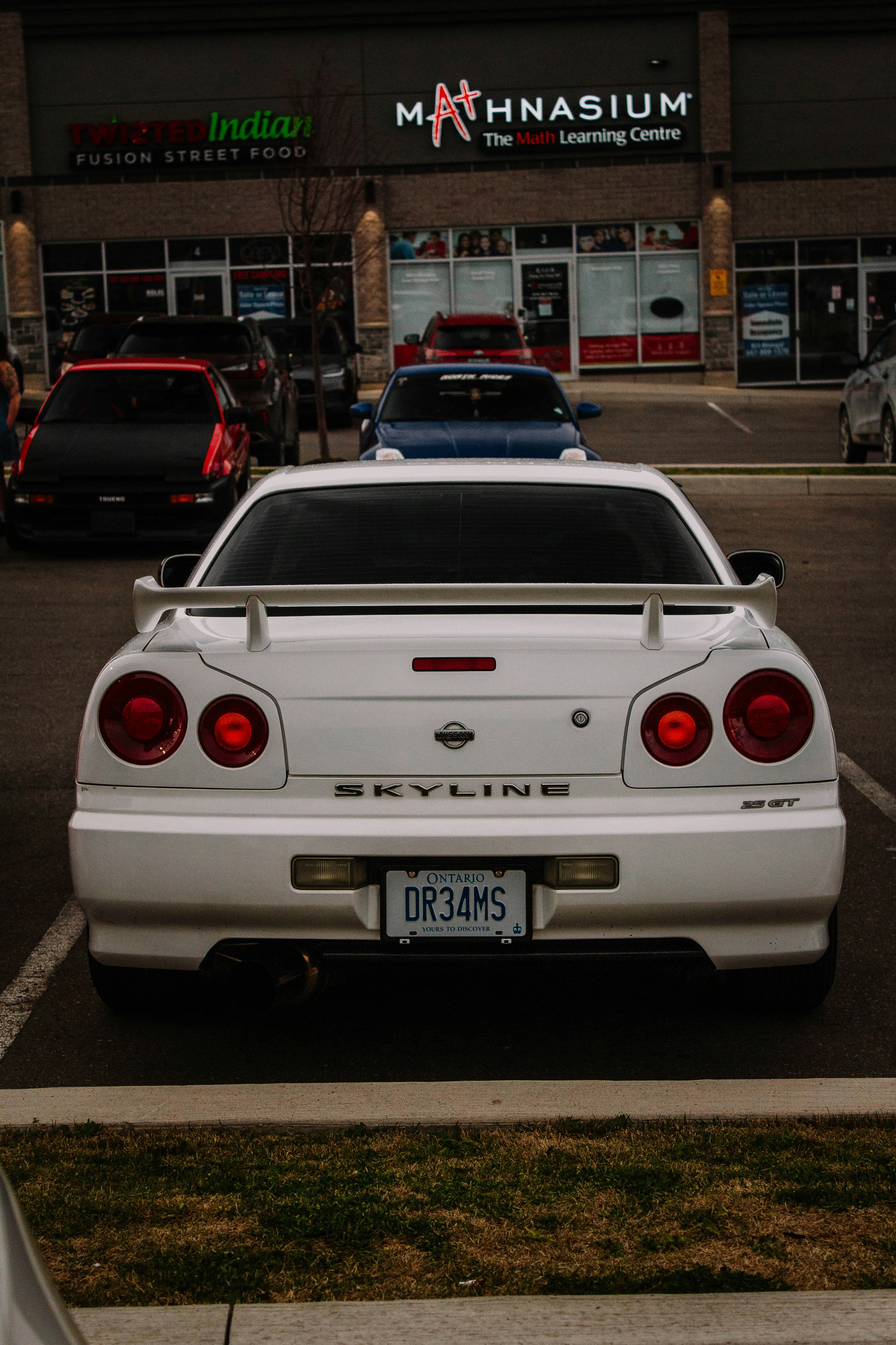 Rear View of a White Nissan Skyline in a Parking Lot Fronting a Math Learning Centre